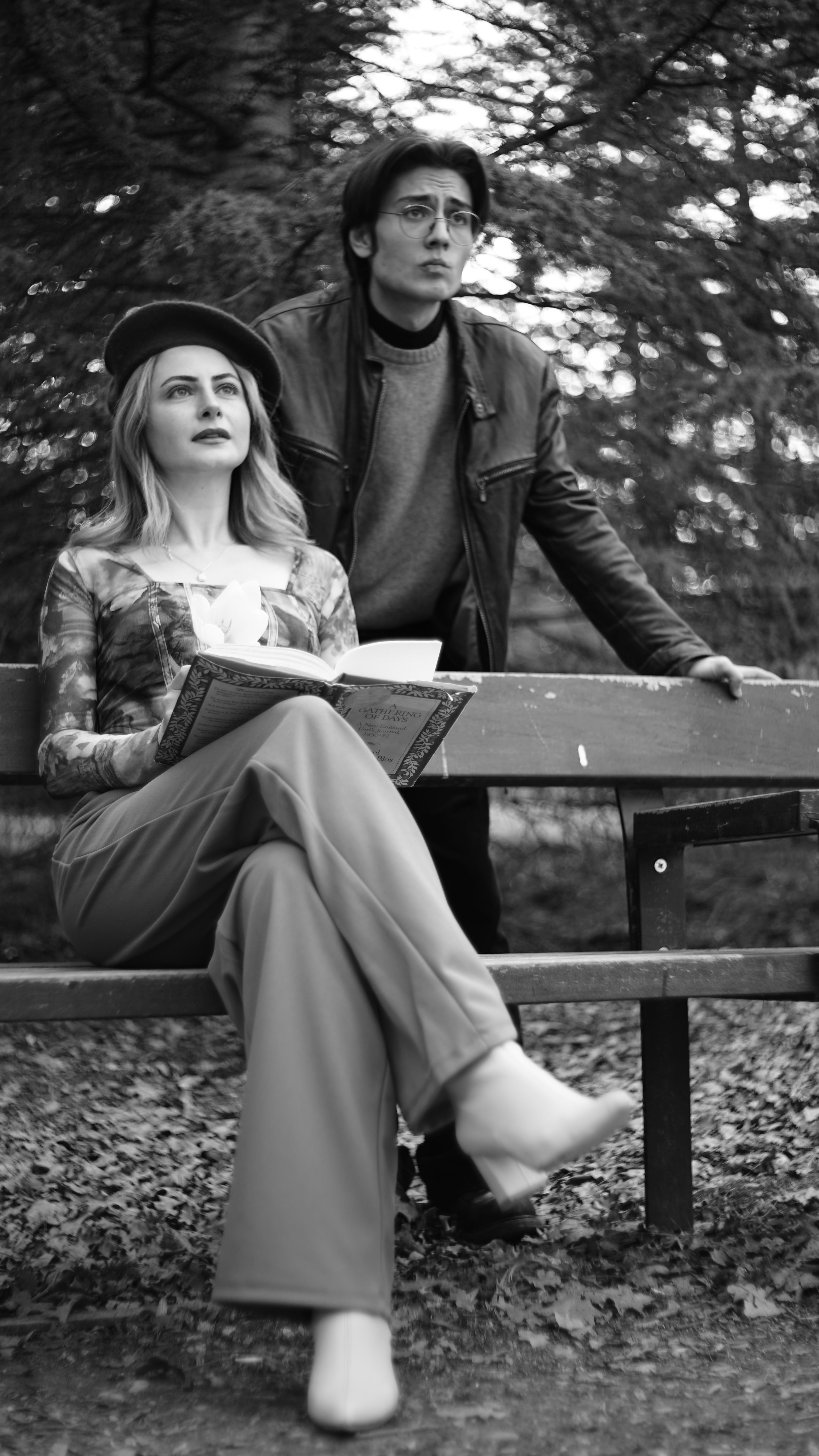 A man and woman sitting on a bench in the woods · Free Stock Photo