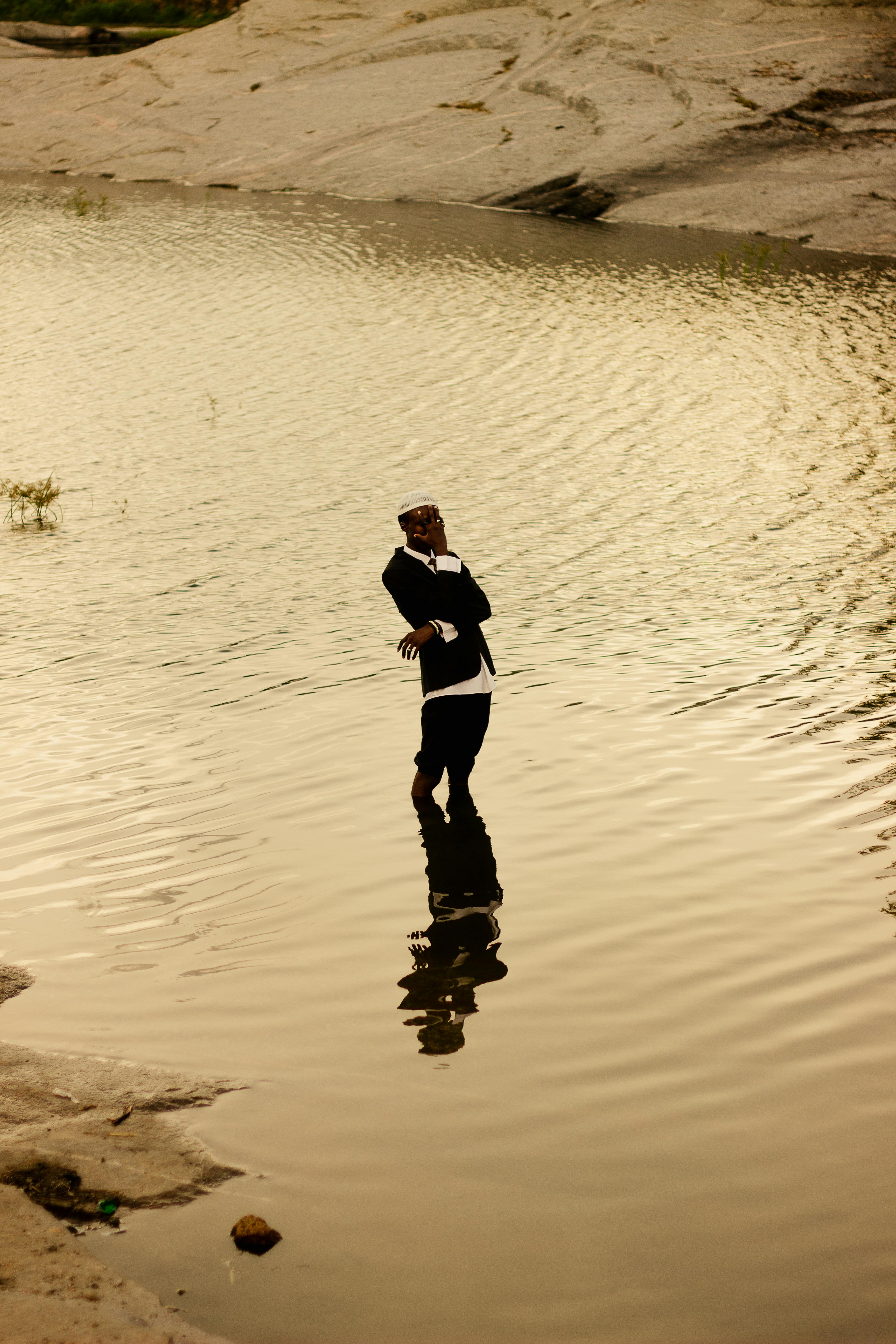 Man in Suit Standing in Lake · Free Stock Photo