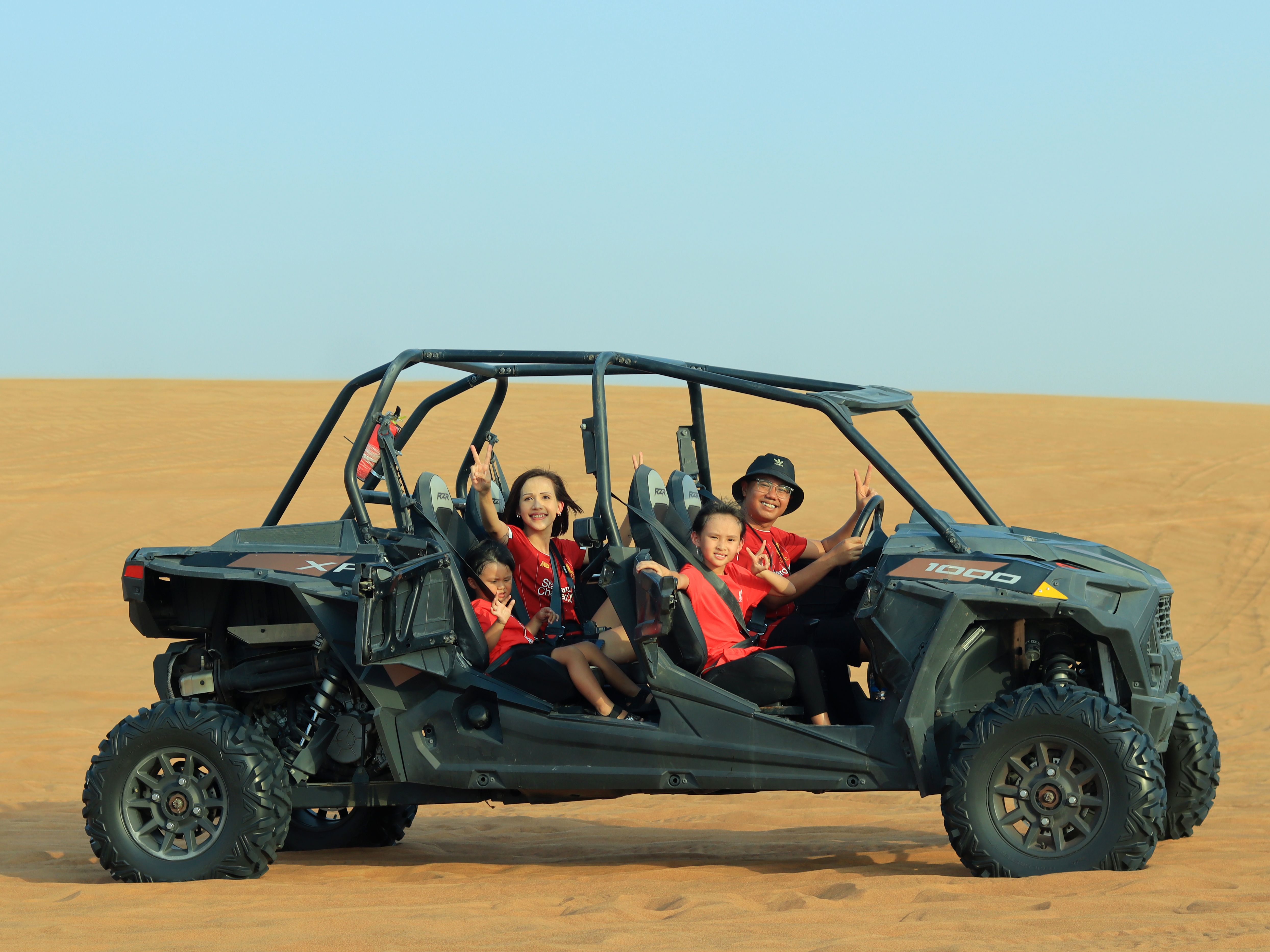 Smiling Family Riding Buggy on Desert · Free Stock Photo