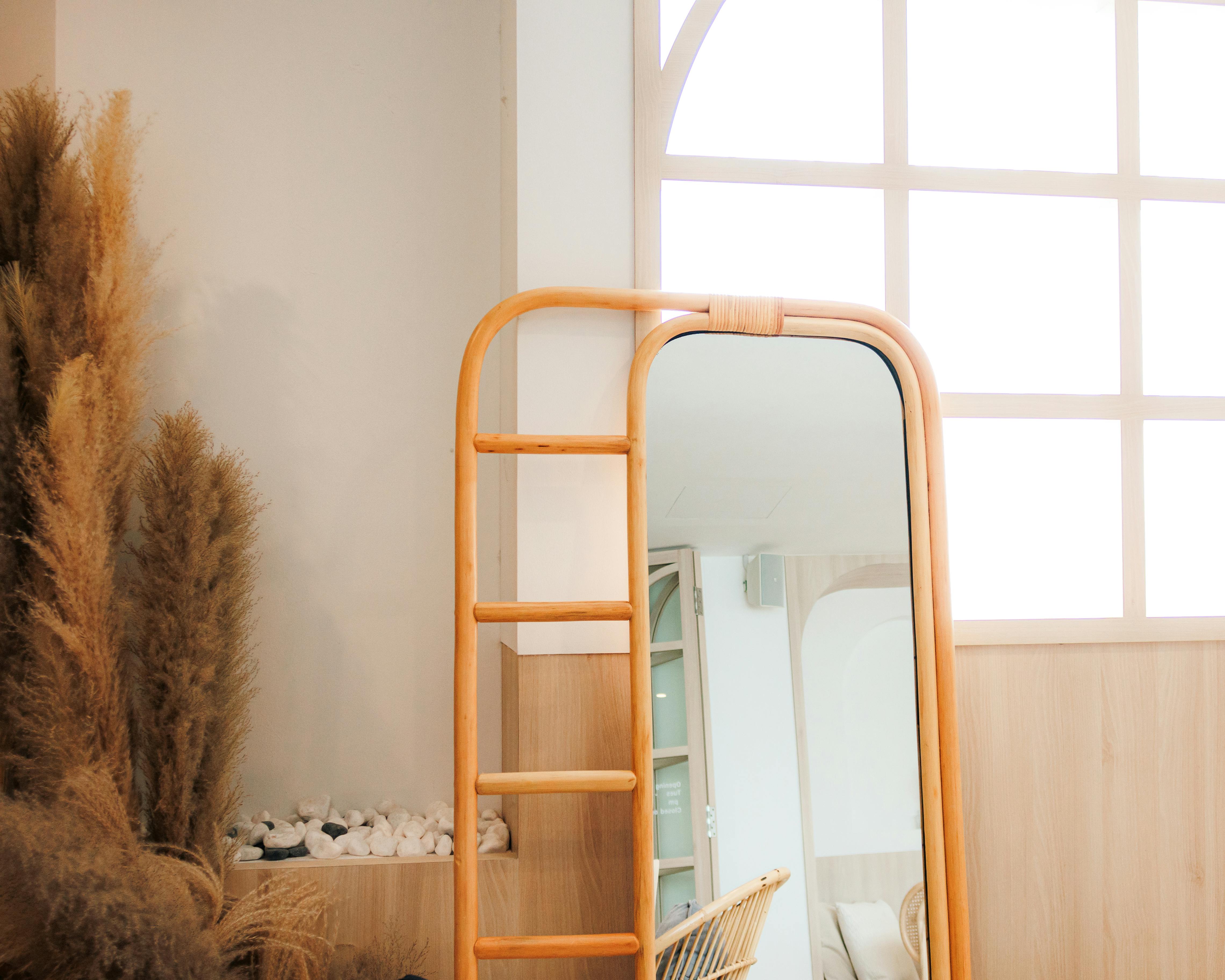 A ladder is in front of a mirror in a room · Free Stock Photo