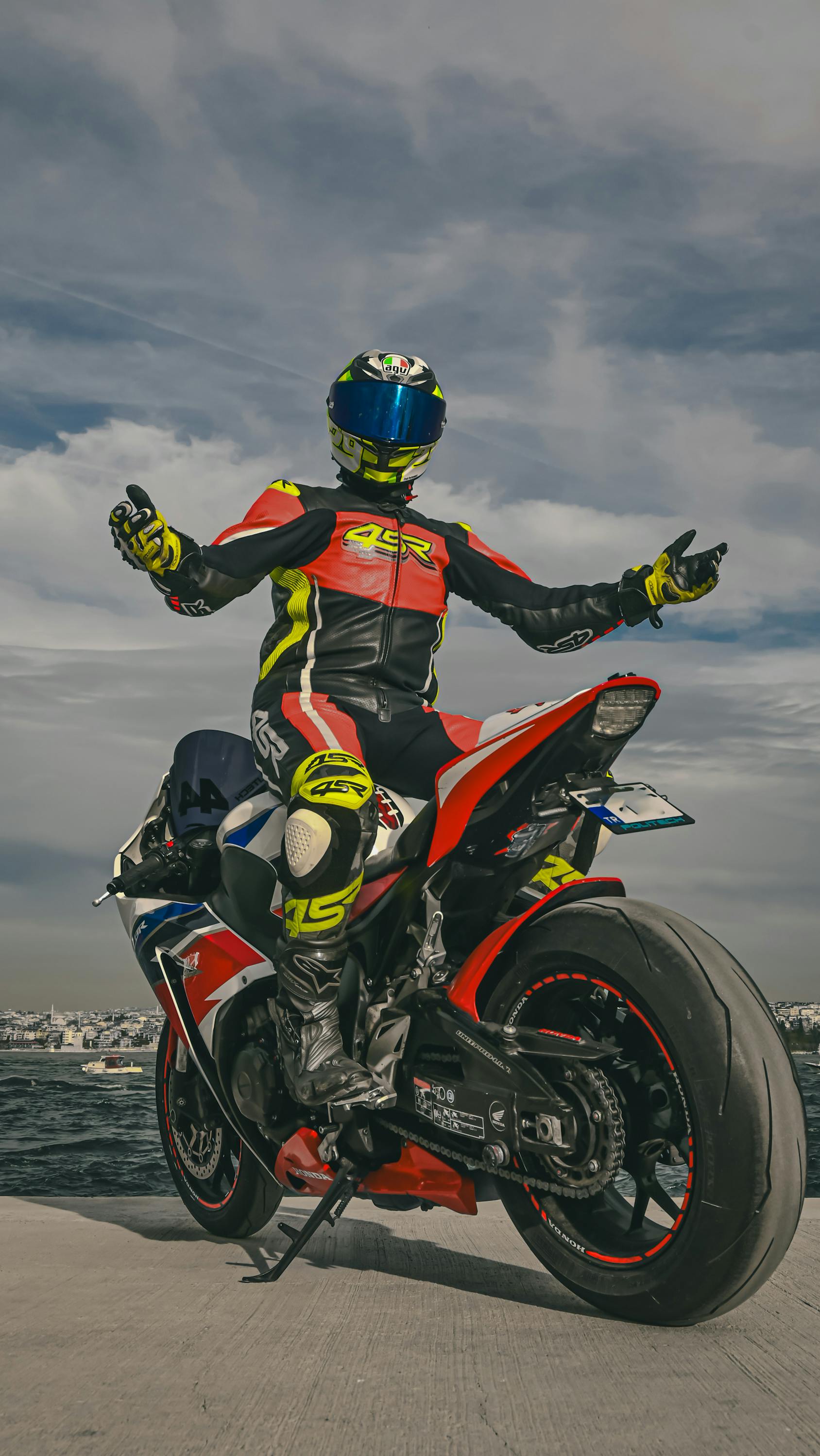 Man in Racing Suit Sitting on Motorcycle · Free Stock Photo