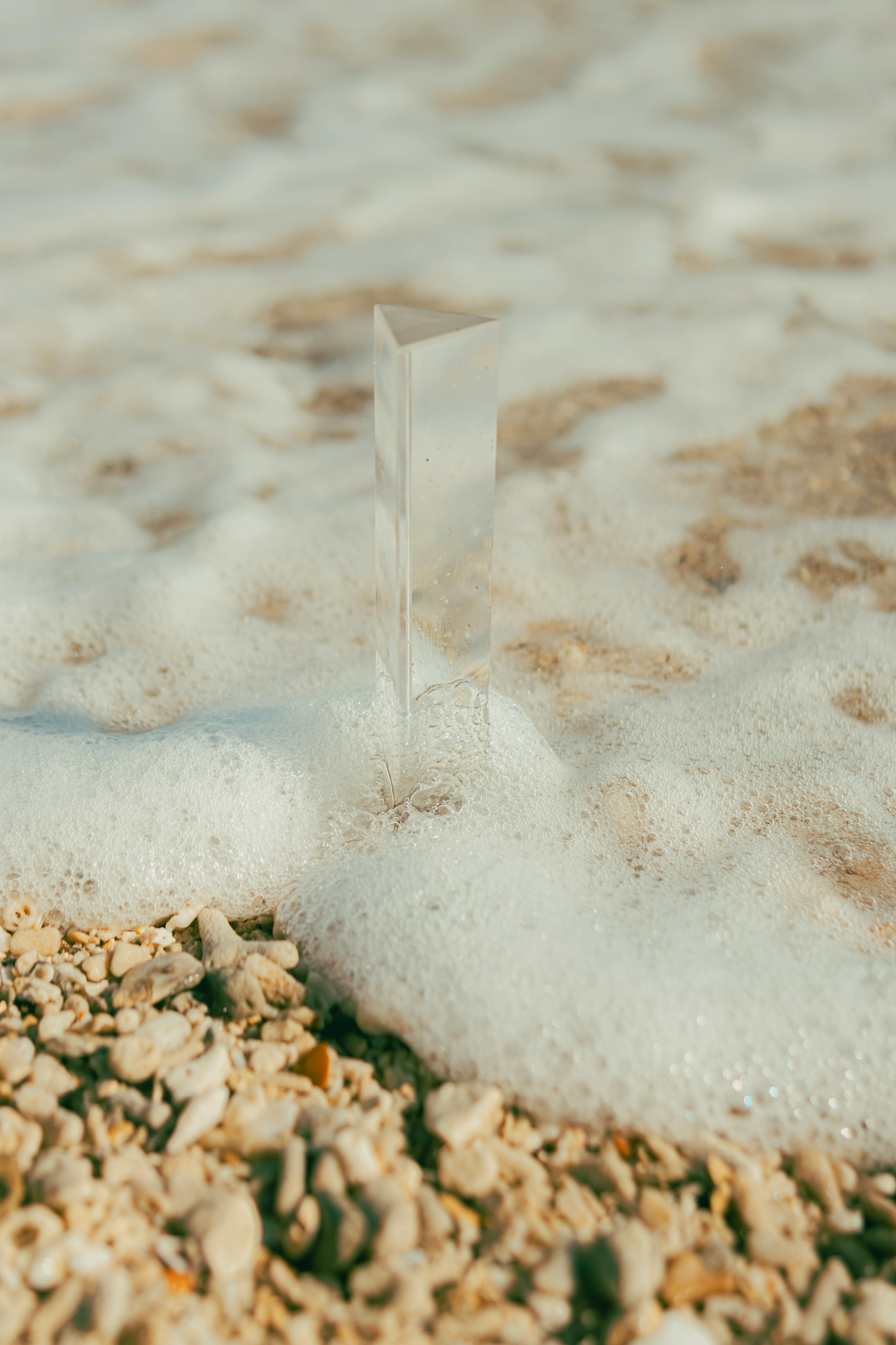 Close-up of a Foamy Wave Washing Up the Beach · Free Stock Photo