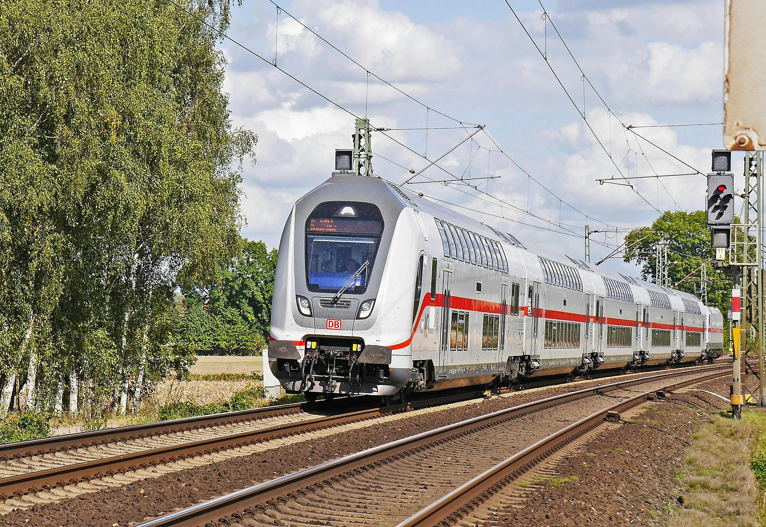 Train by Trees Against Blue Sky · Free Stock Photo