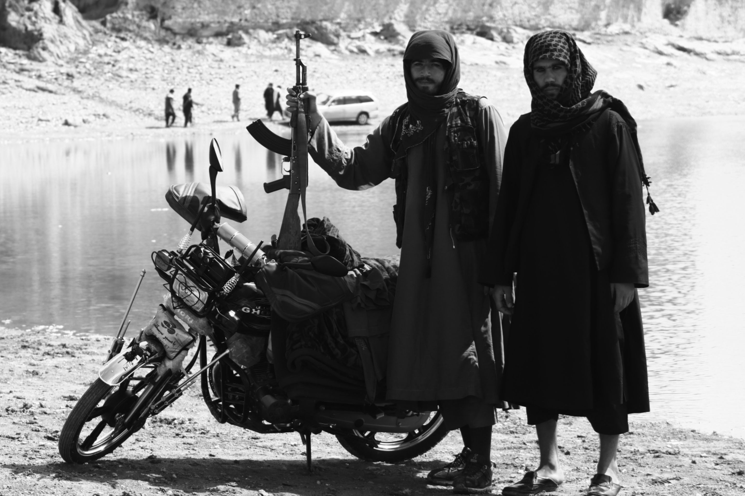 Two Men in Turban Standing next to a Motorcycle with a Weapon · Free ...
