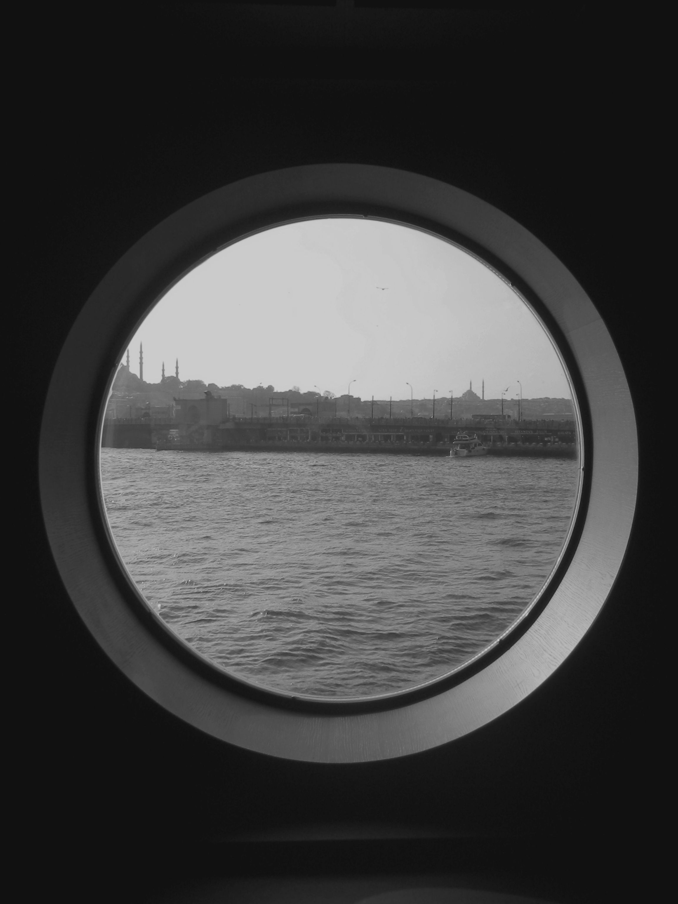 A porthole window looking out at the ocean · Free Stock Photo