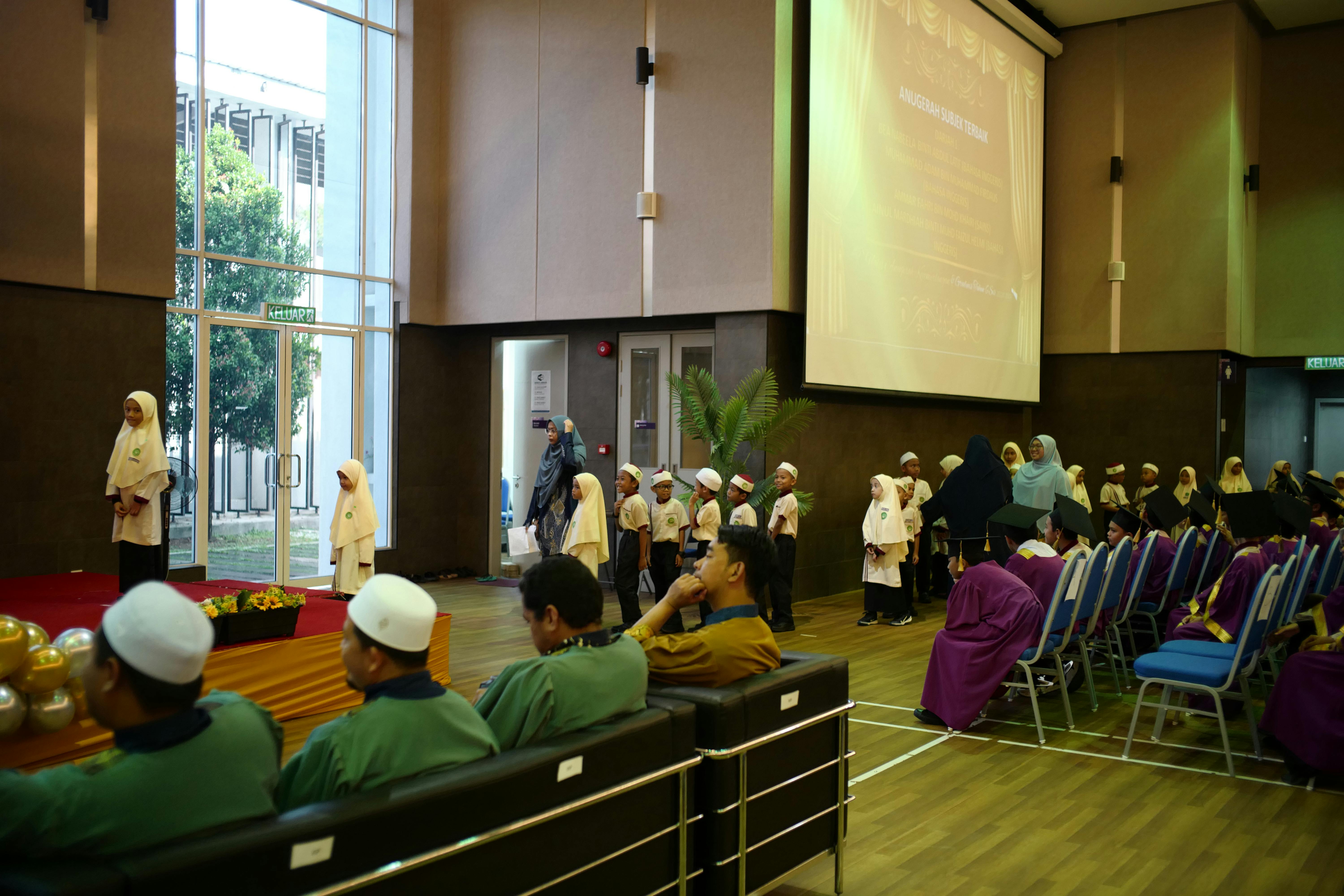 People Watching Children at the Graduation Ceremony · Free Stock Photo