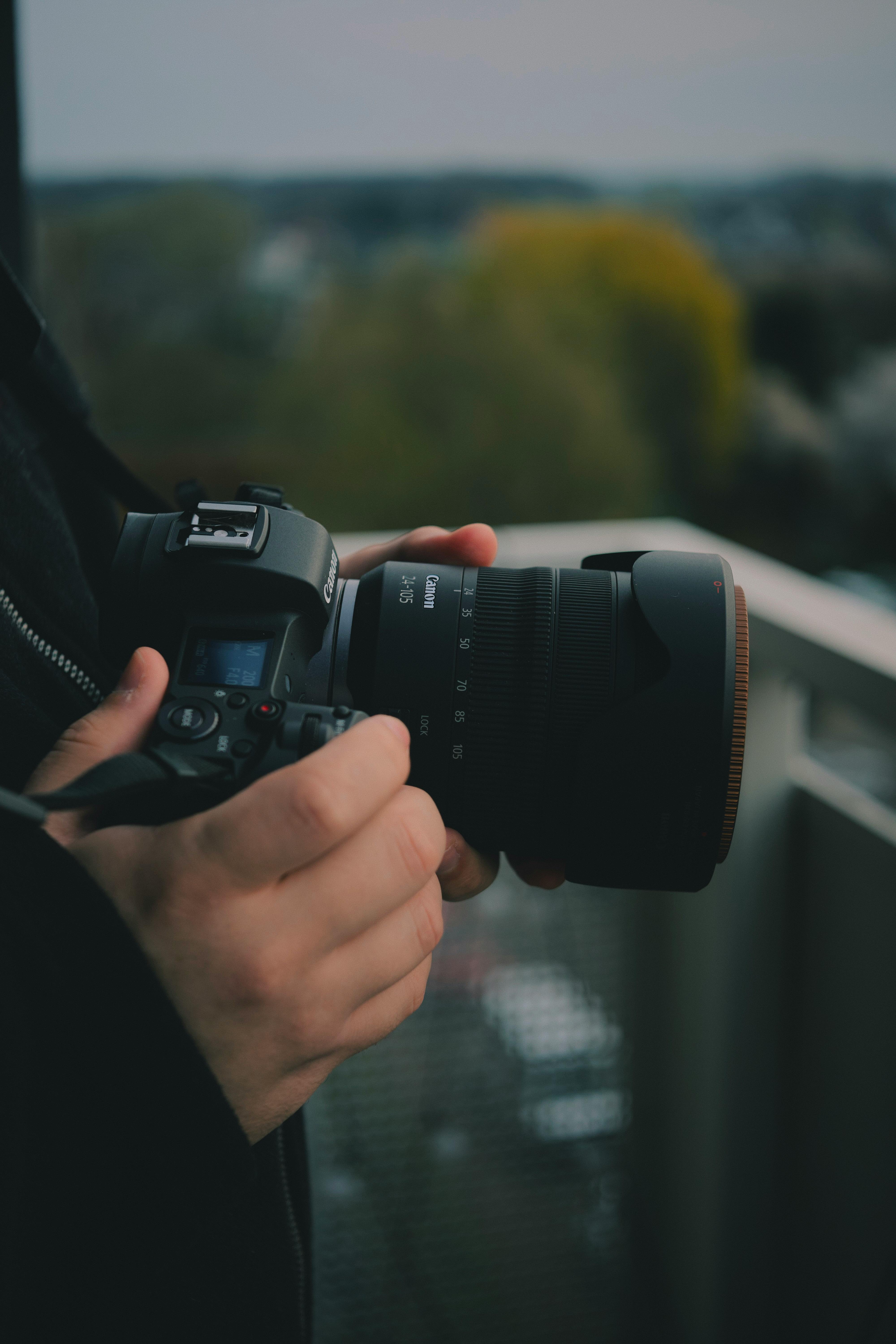 Person Holding Camera Lens · Free Stock Photo