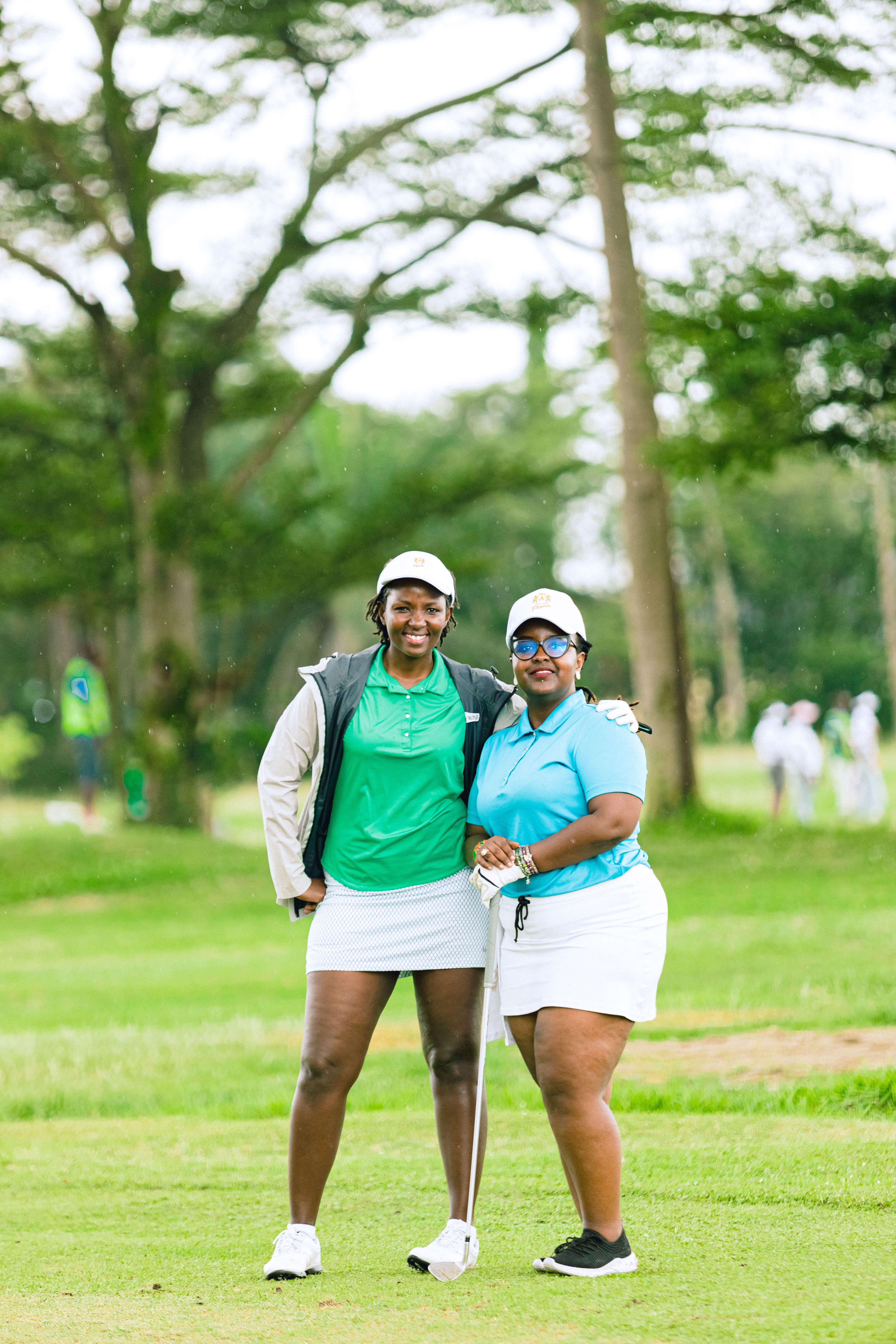 Two Golf Players Posing for a Picture · Free Stock Photo