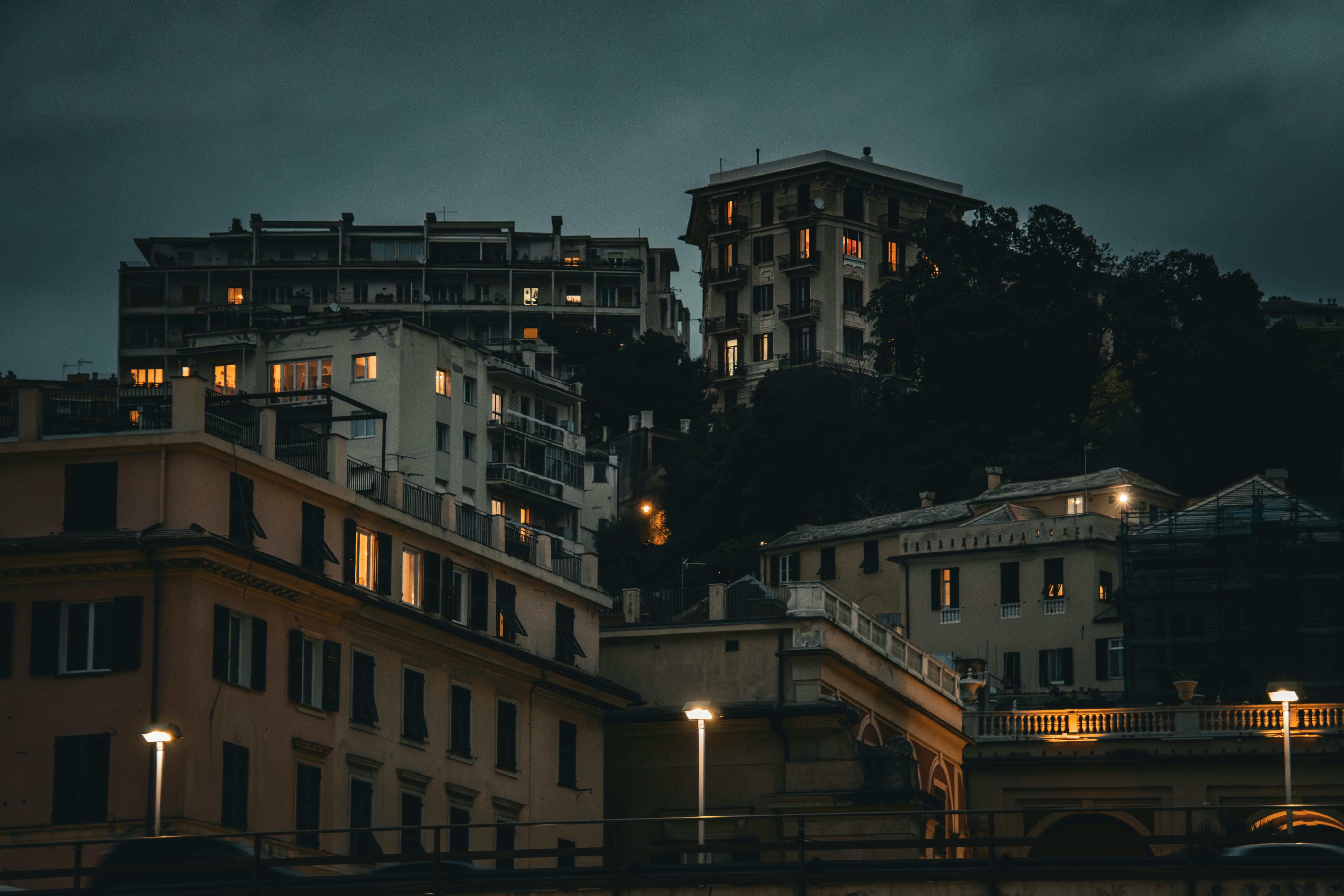 Black High Rise Building Under Grey and White Sky during Night Time ...