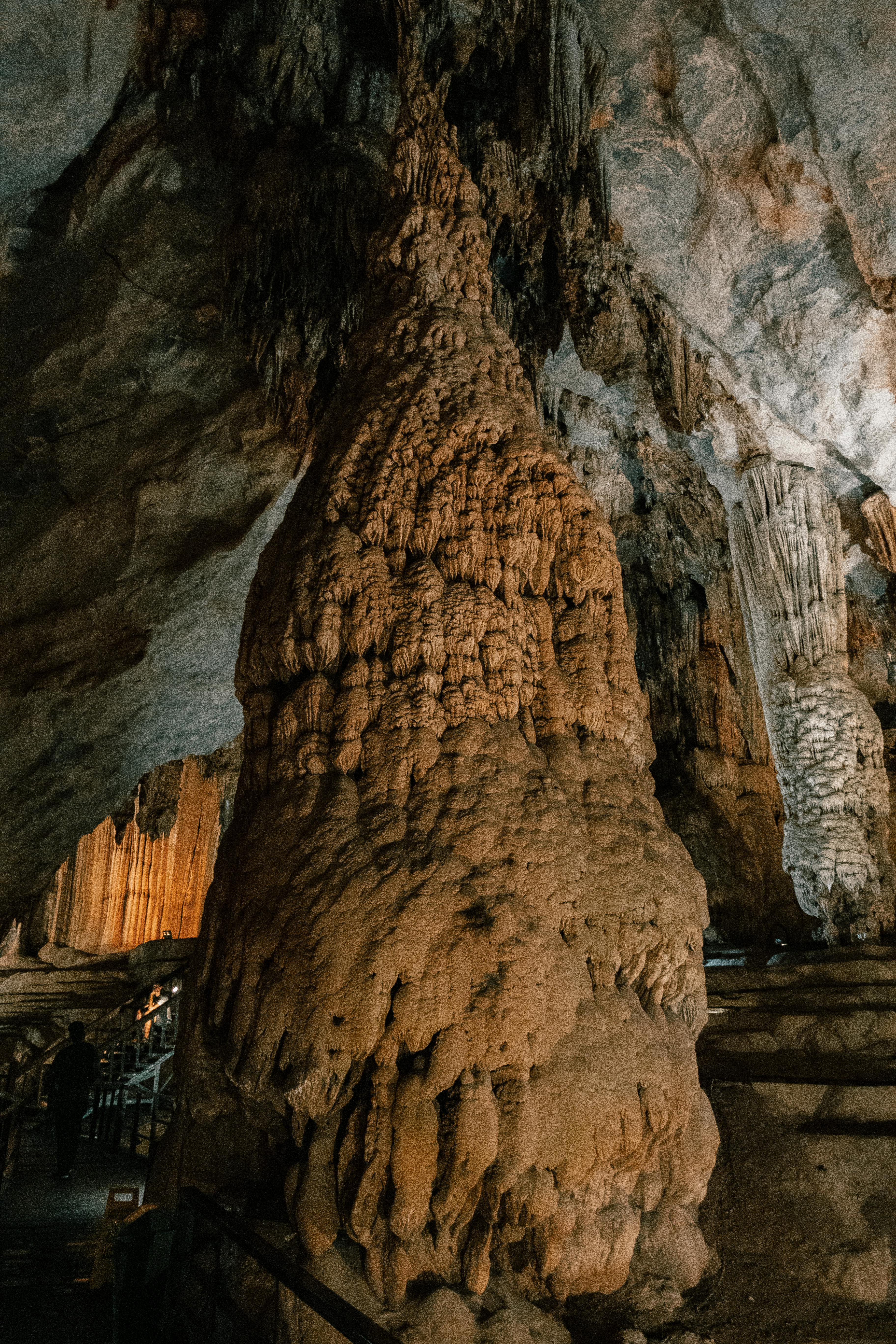 Person Standing in Muddy Cave Entrance · Free Stock Photo