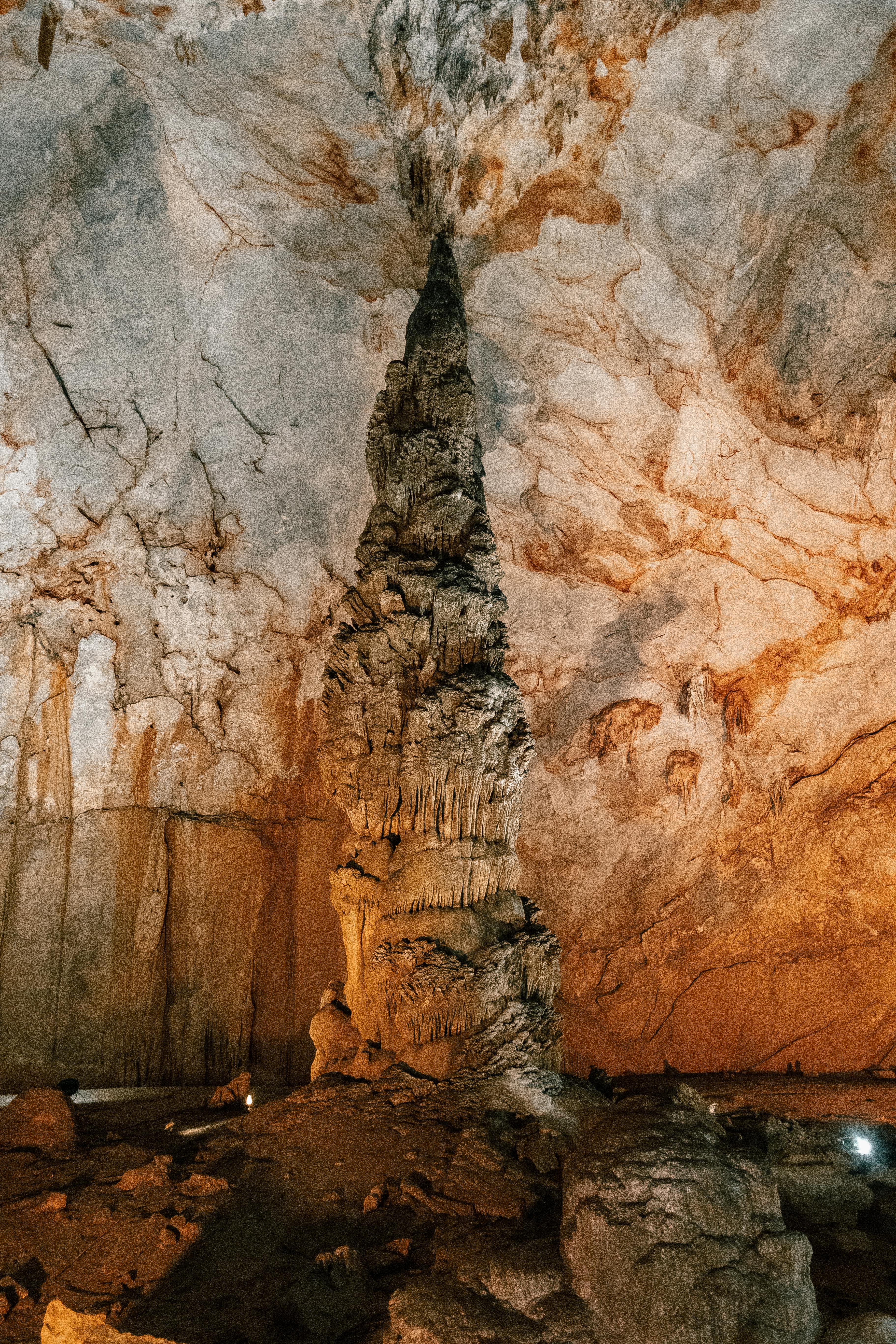 A large stone pillar in a cave · Free Stock Photo