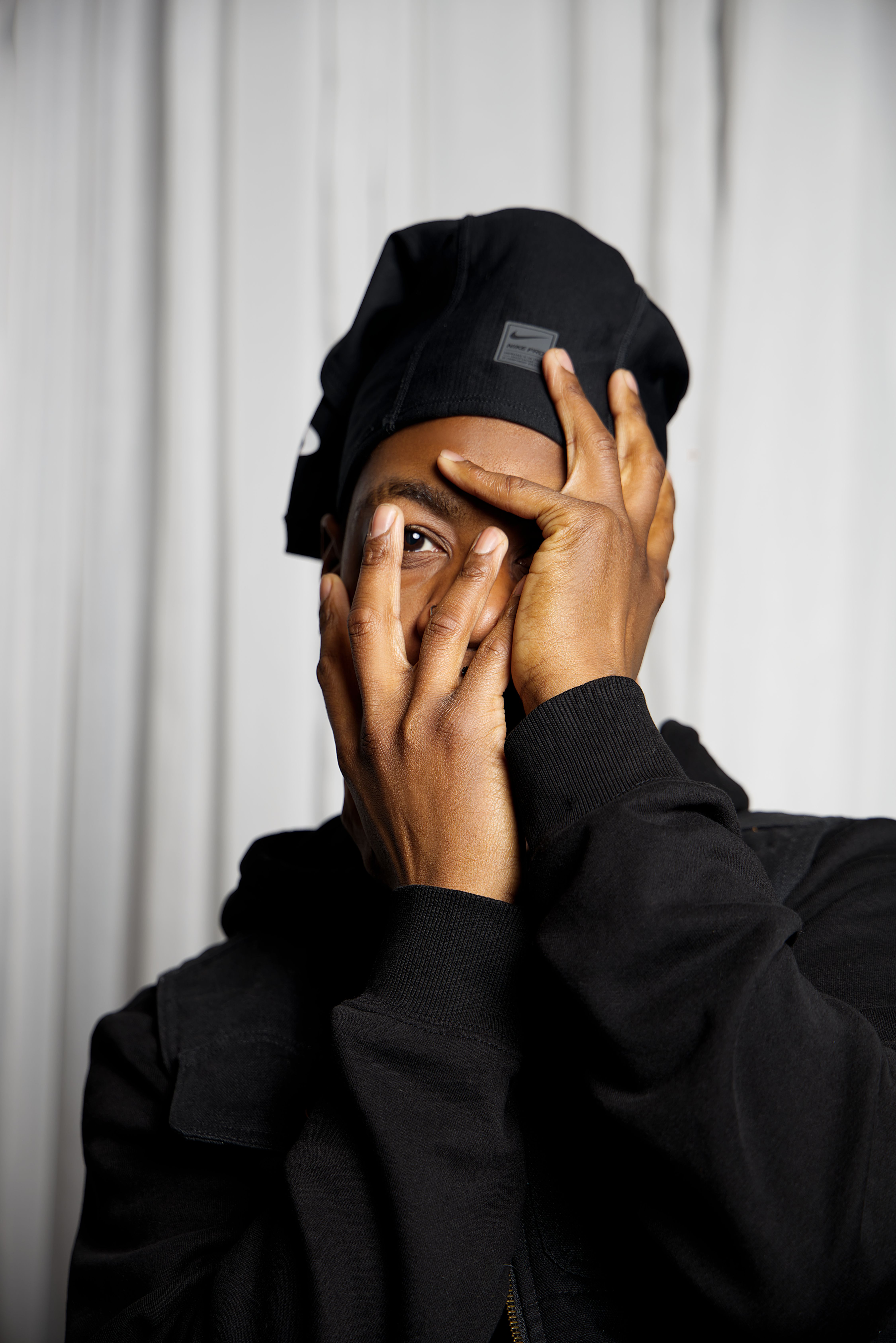A man in a black hat covering his eyes · Free Stock Photo