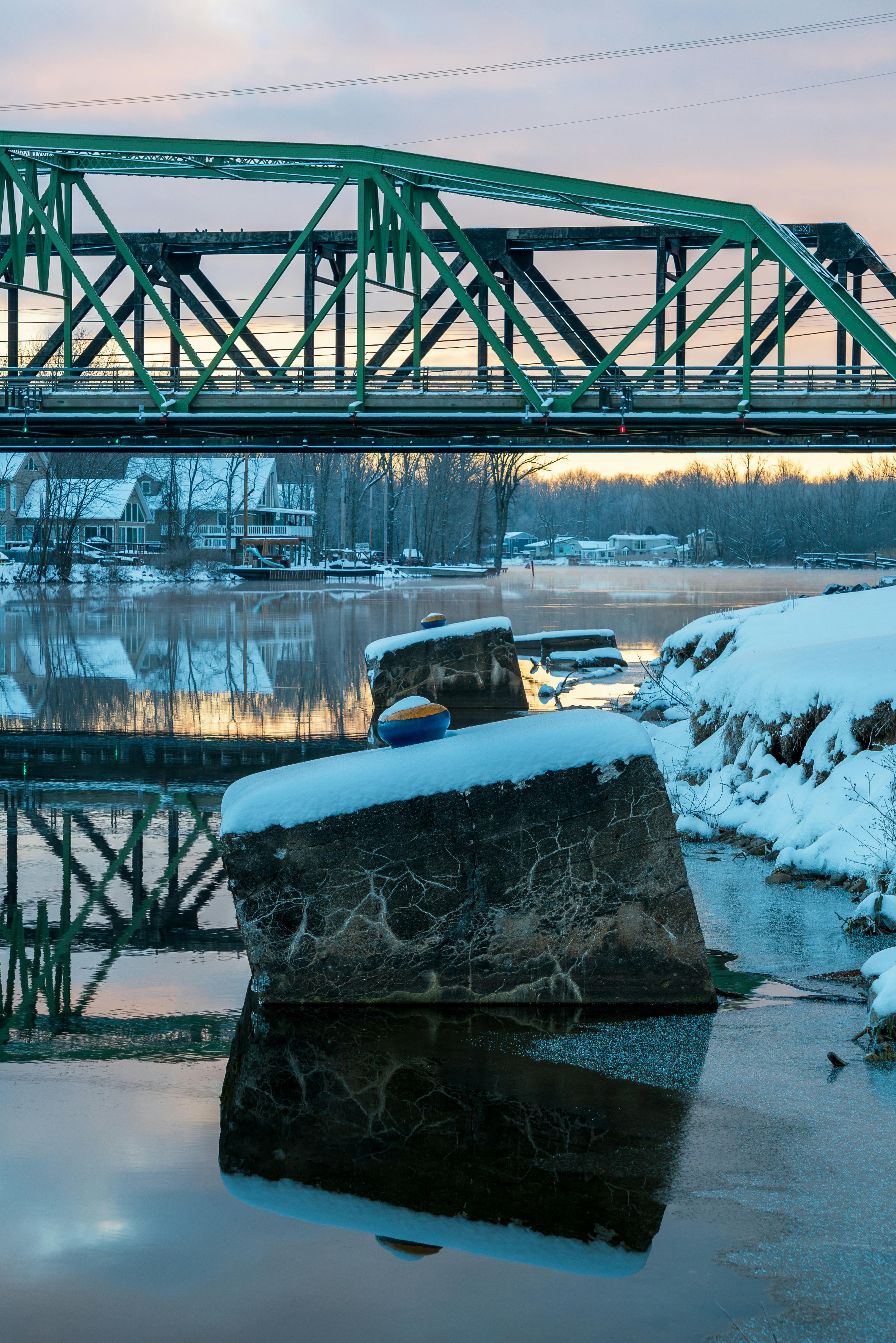 Stone Structure in River Near Bridge · Free Stock Photo