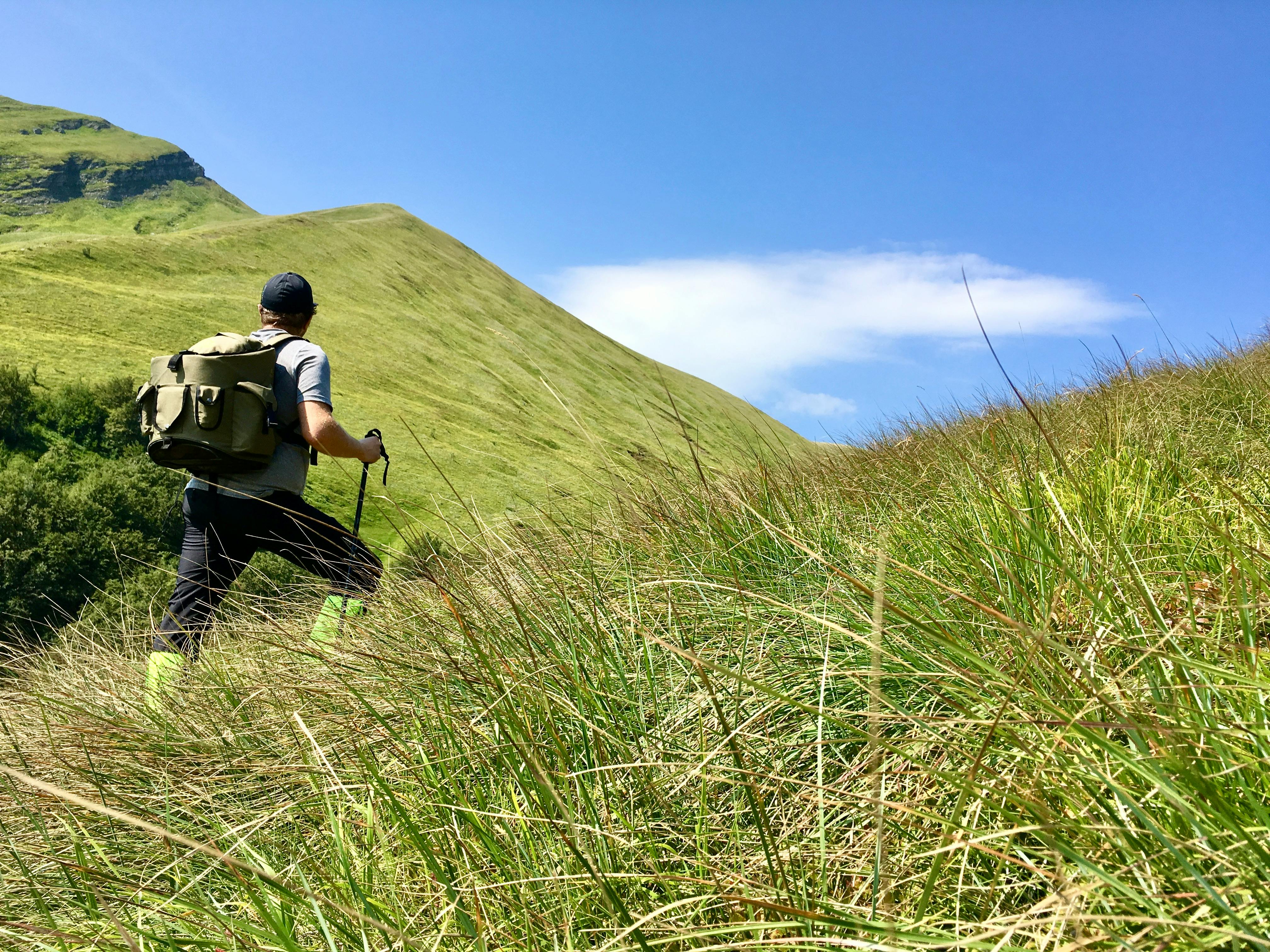 Man Hiking with Backpack on Hills · Free Stock Photo