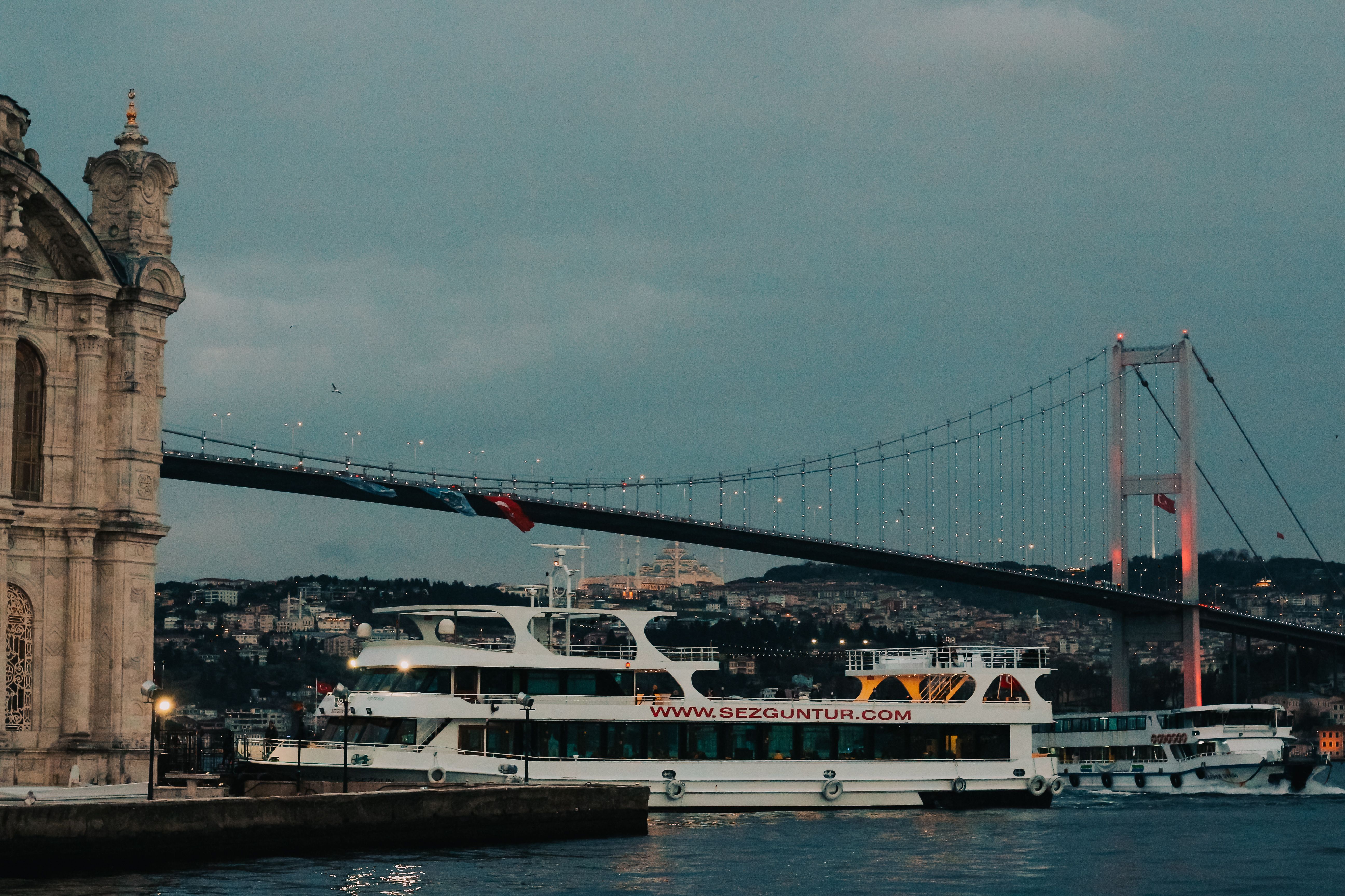 A boat is docked in front of a bridge · Free Stock Photo