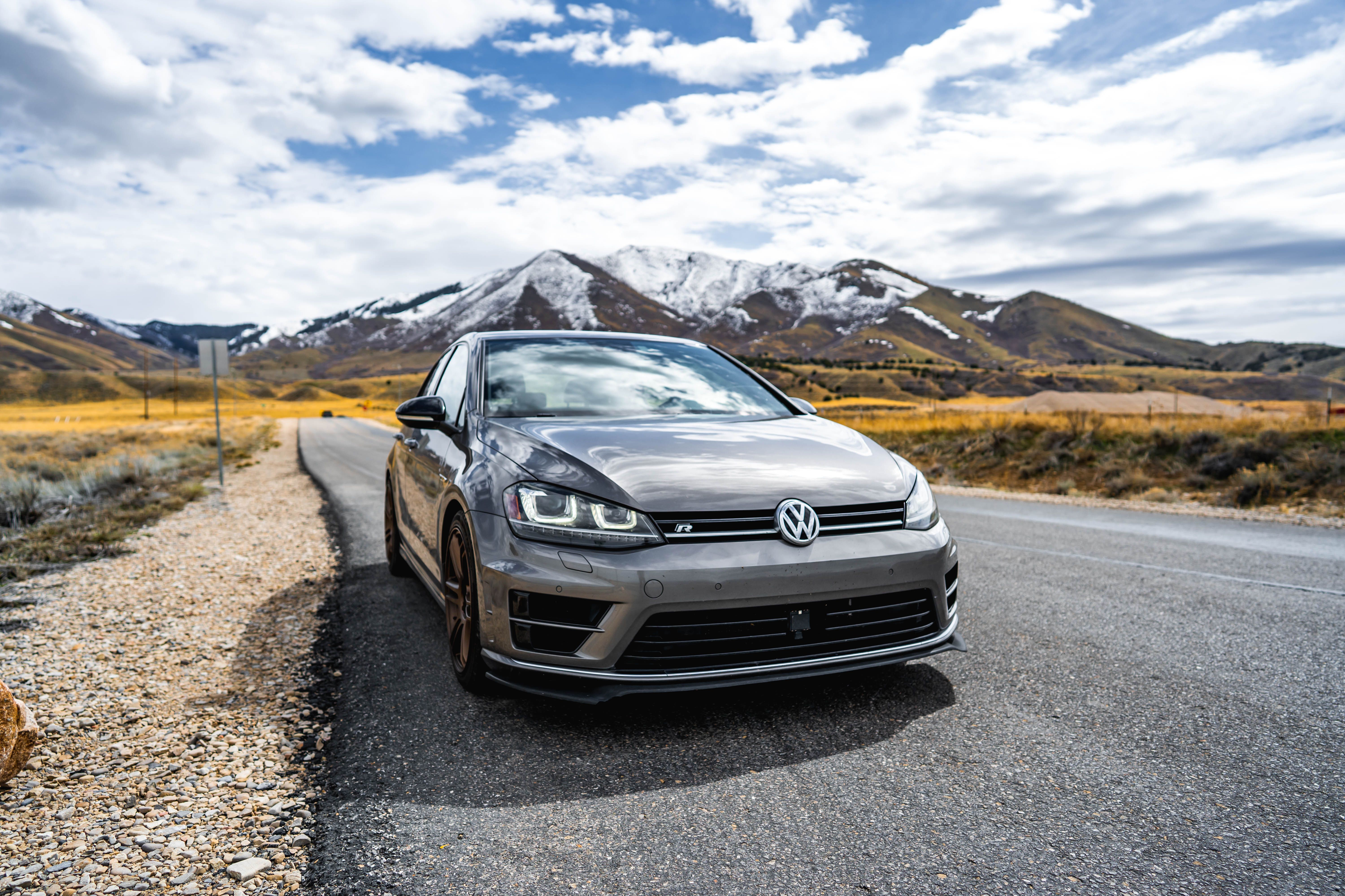 The volkswagen golf r is parked on the side of the road · Free Stock Photo