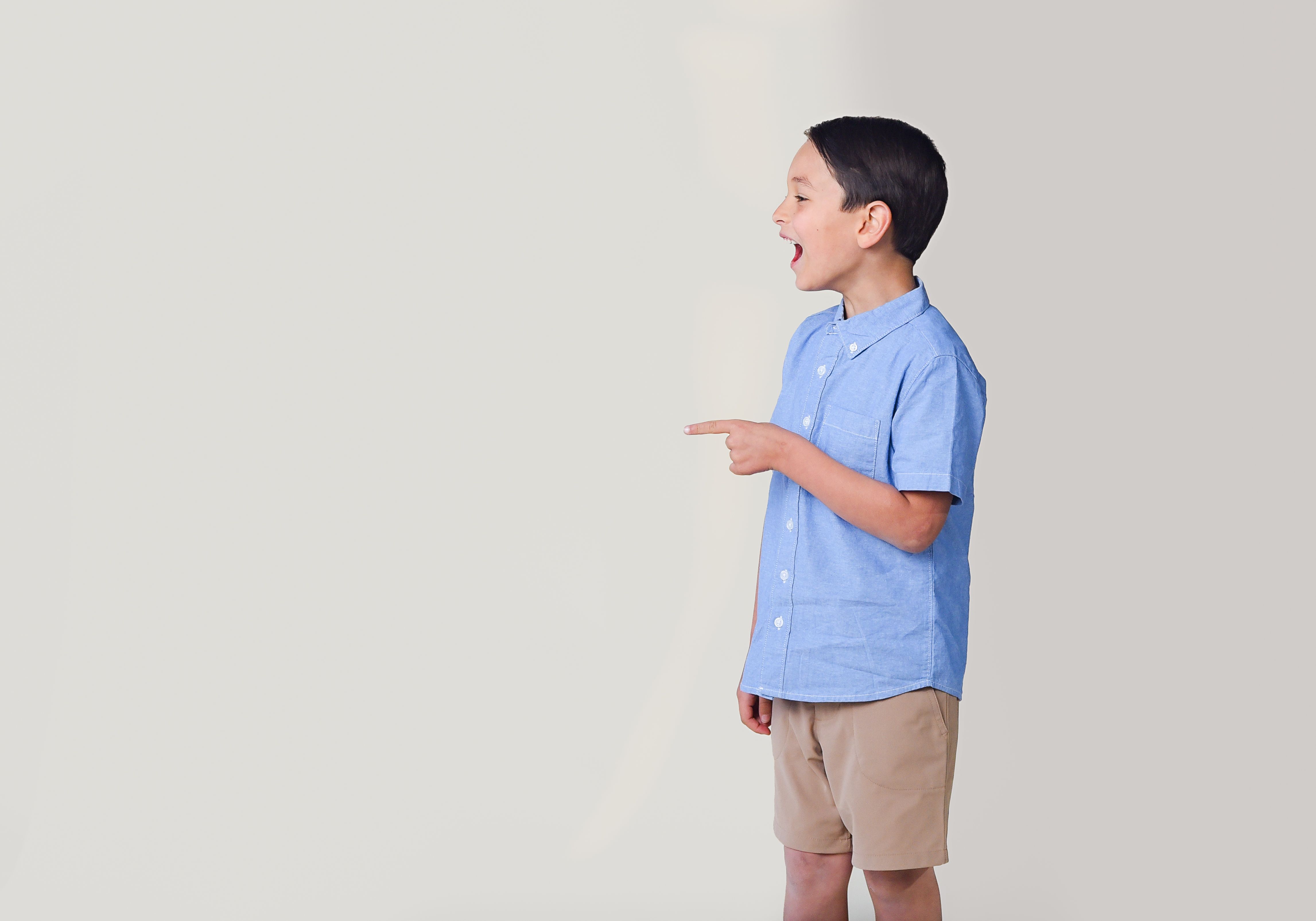 Boy Pointing on a White Background · Free Stock Photo
