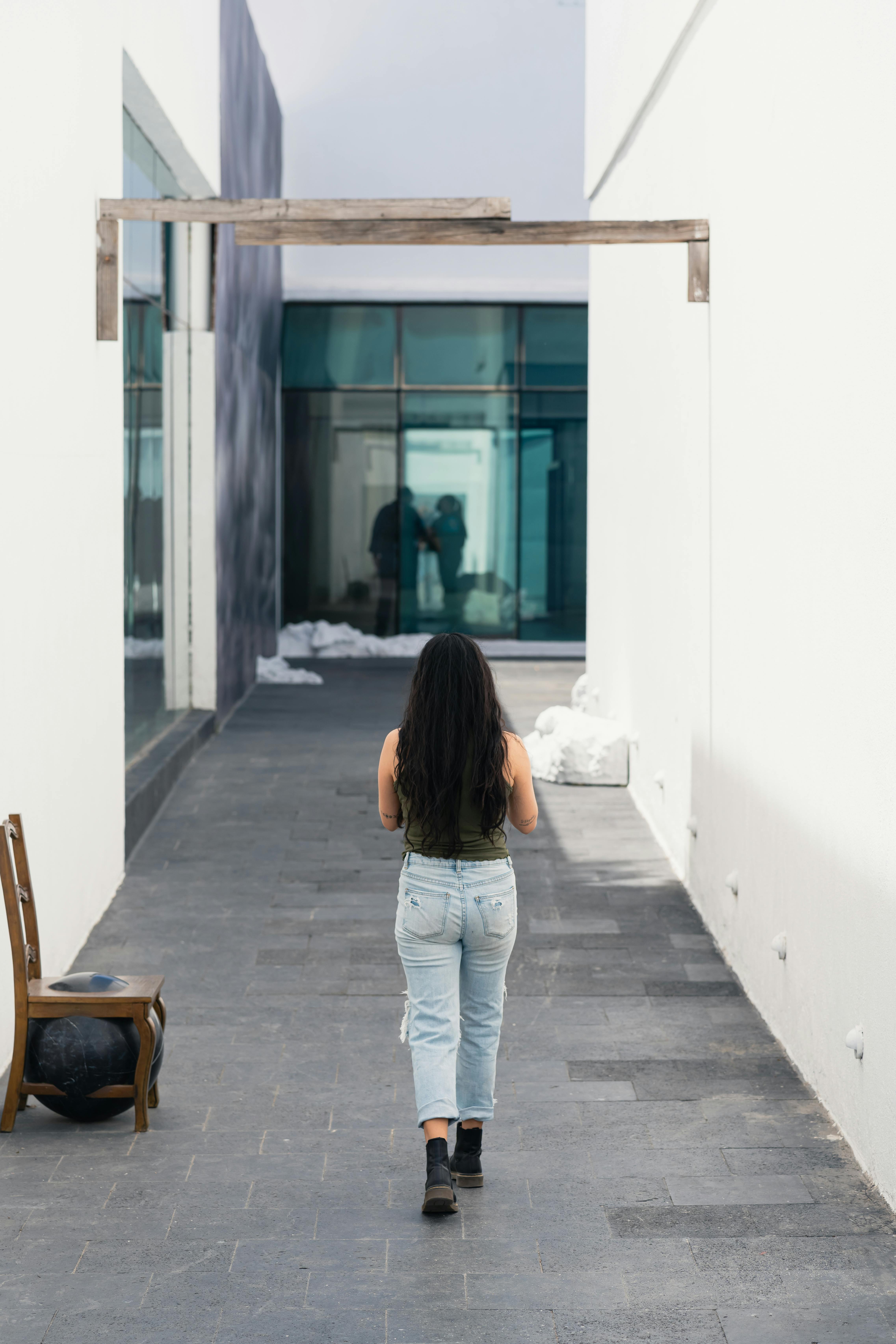 Woman with Long, Black Hair Walking in Jeans · Free Stock Photo