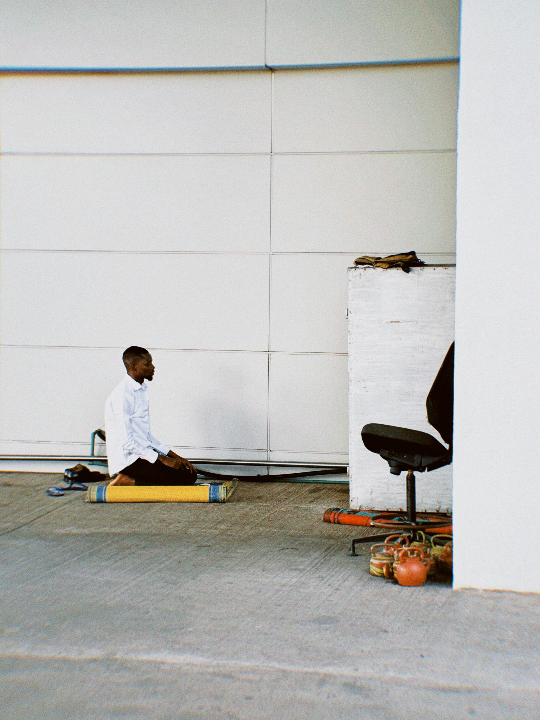 Man Kneeling on Carpet and Praying · Free Stock Photo