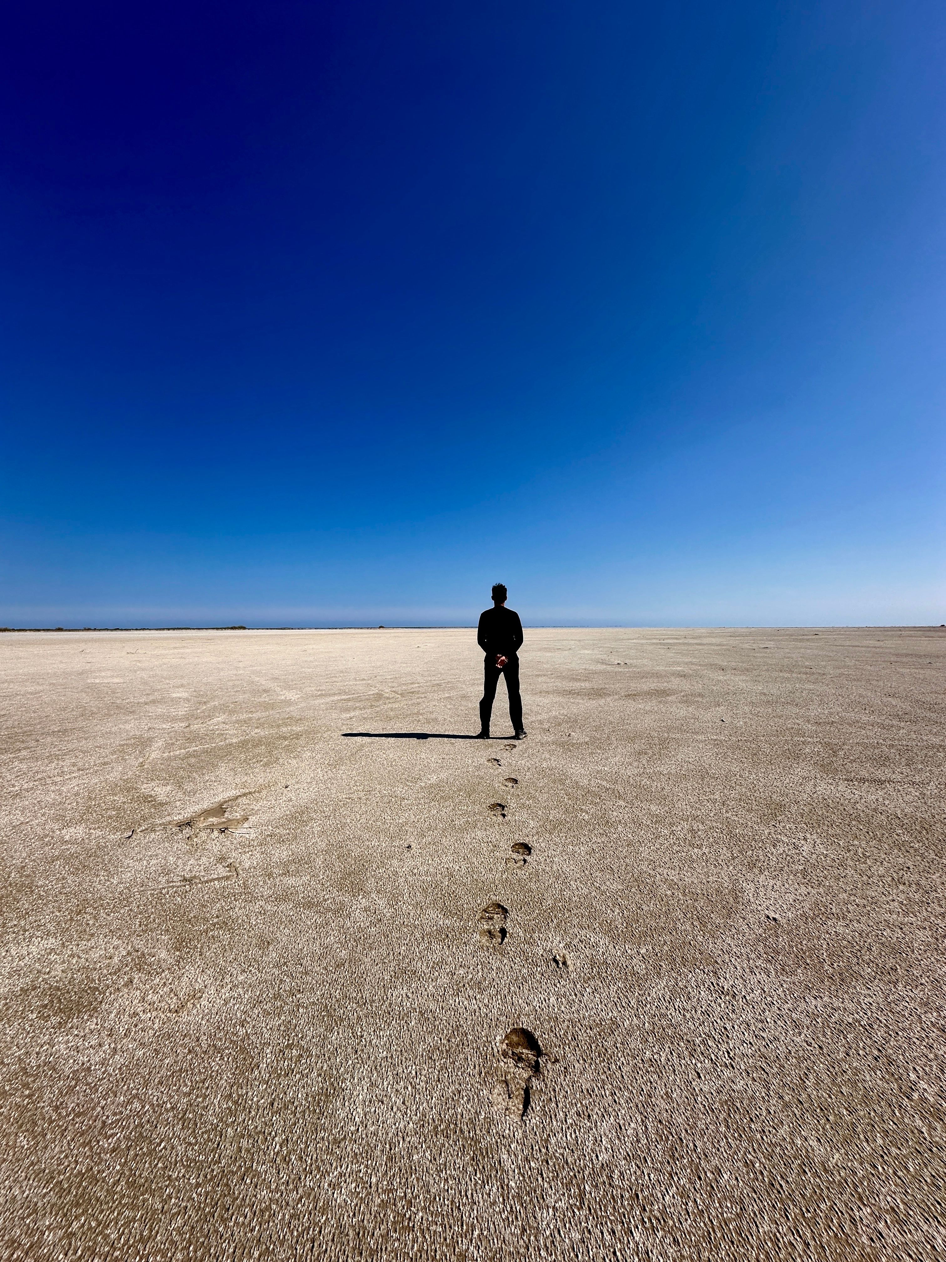 Man Sitting Alone In Desert