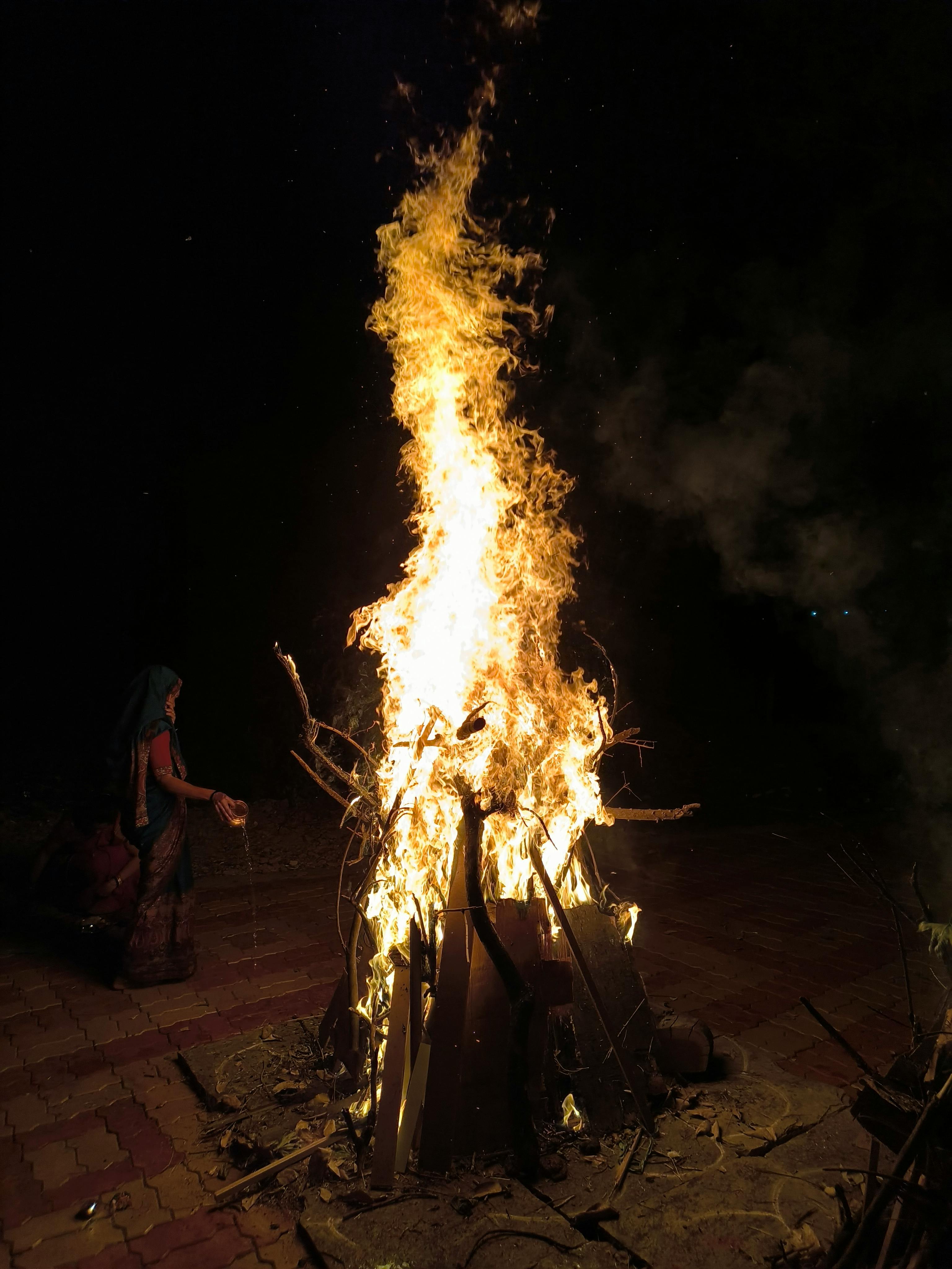 Woman Walking near Bonfire at Night · Free Stock Photo