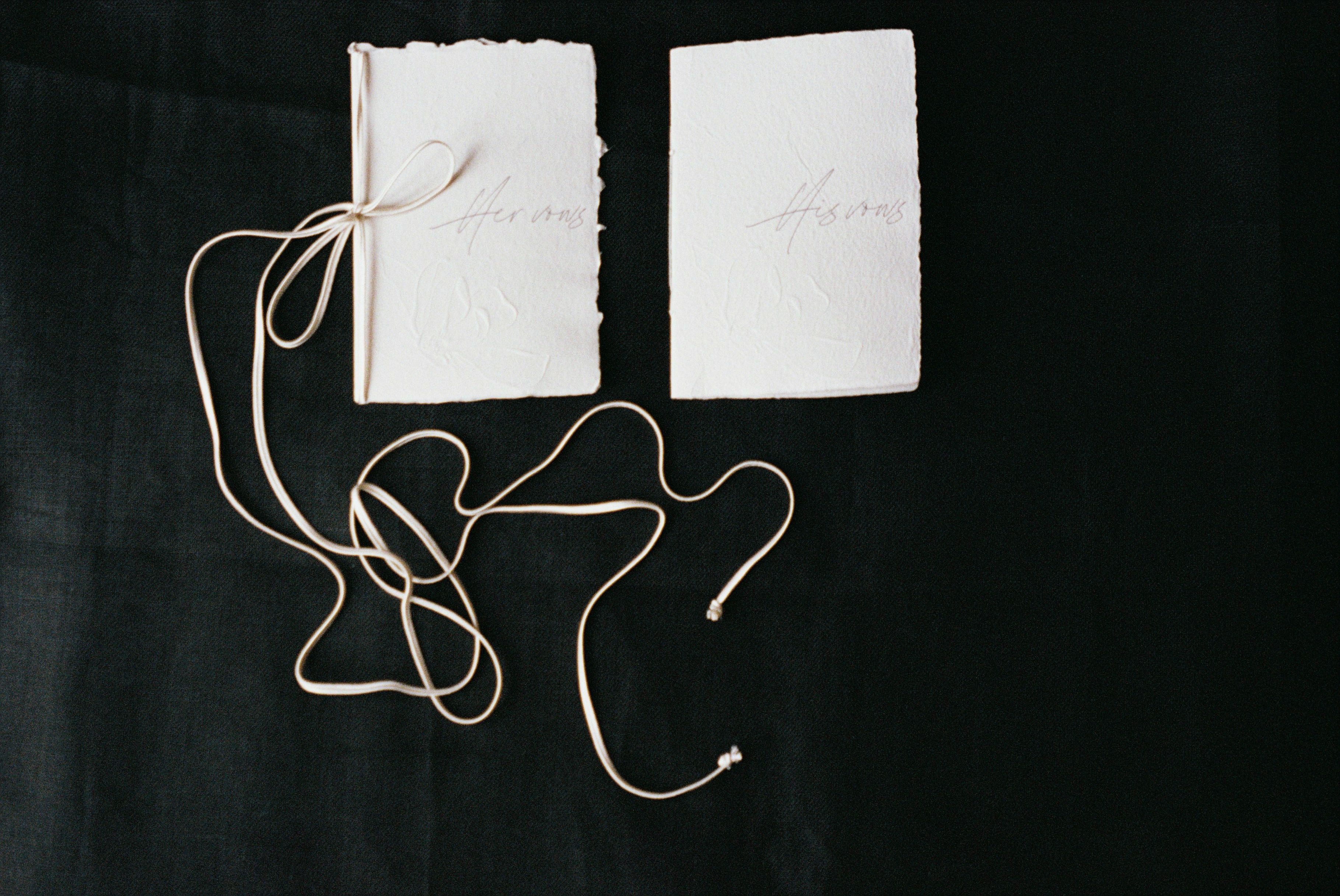 Two white books with a string tied to them · Free Stock Photo