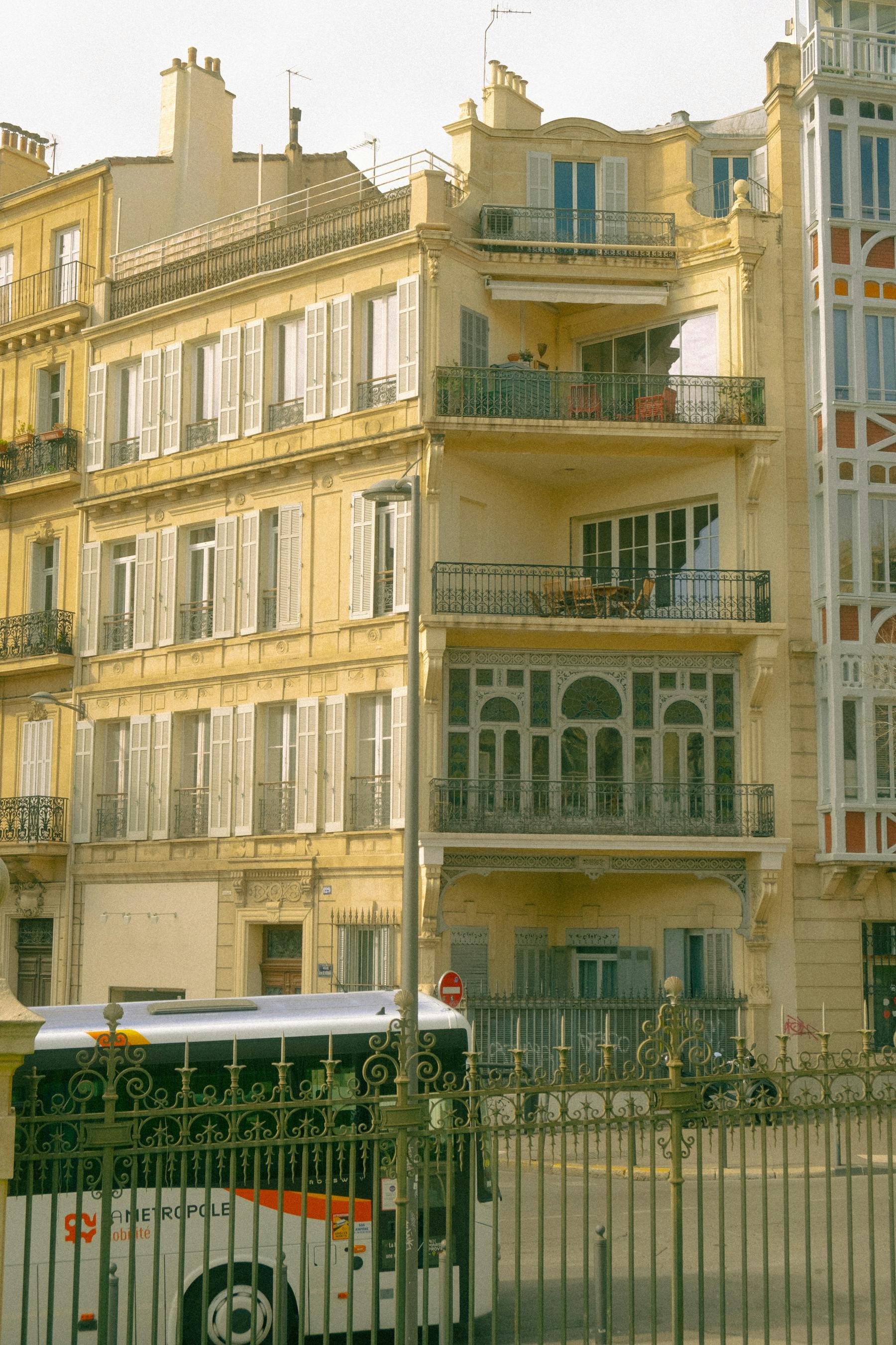 View of a Bus on a Street and an Apartment Building with Balconies in a ...