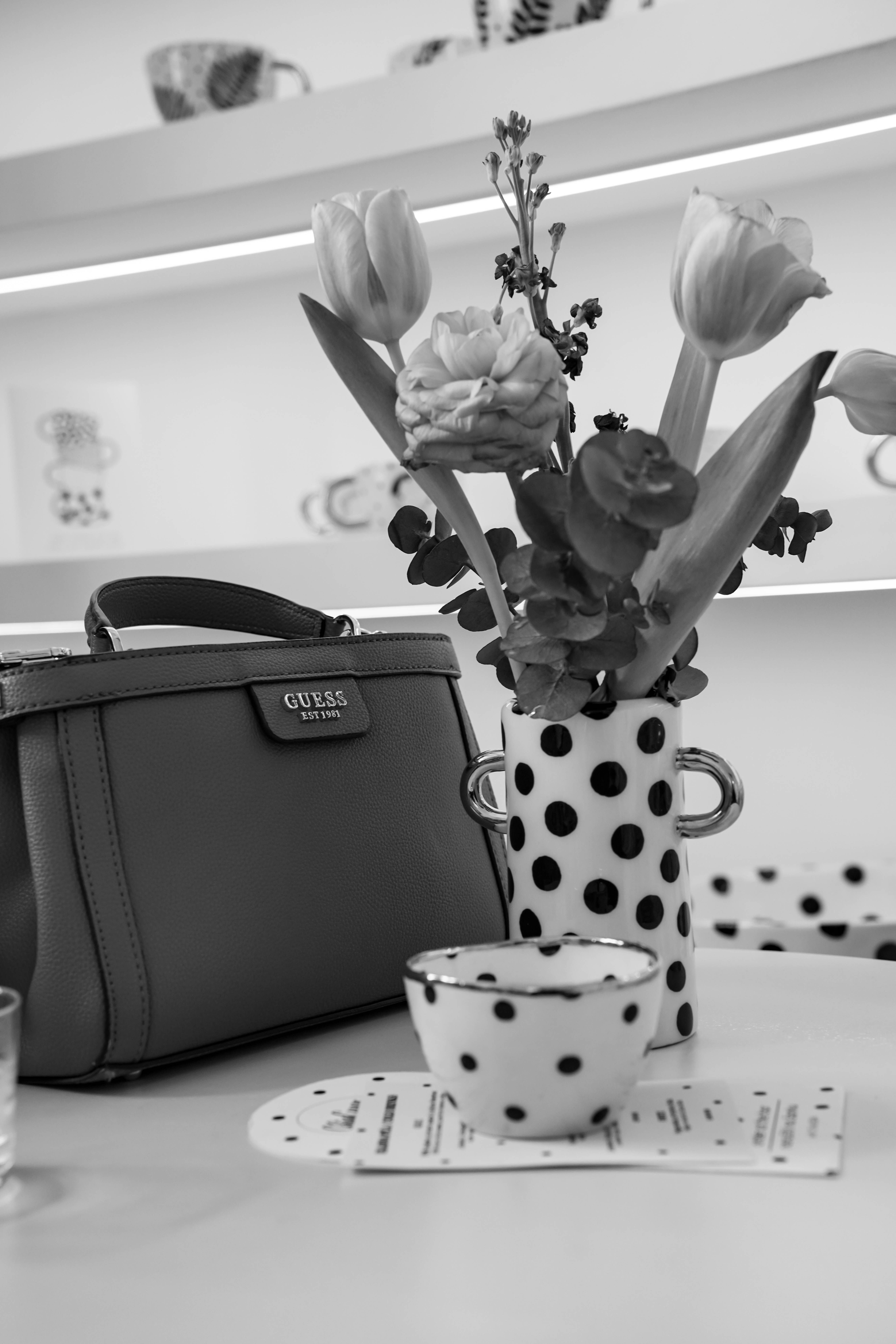 Roses and Guess Bag on Table · Free Stock Photo