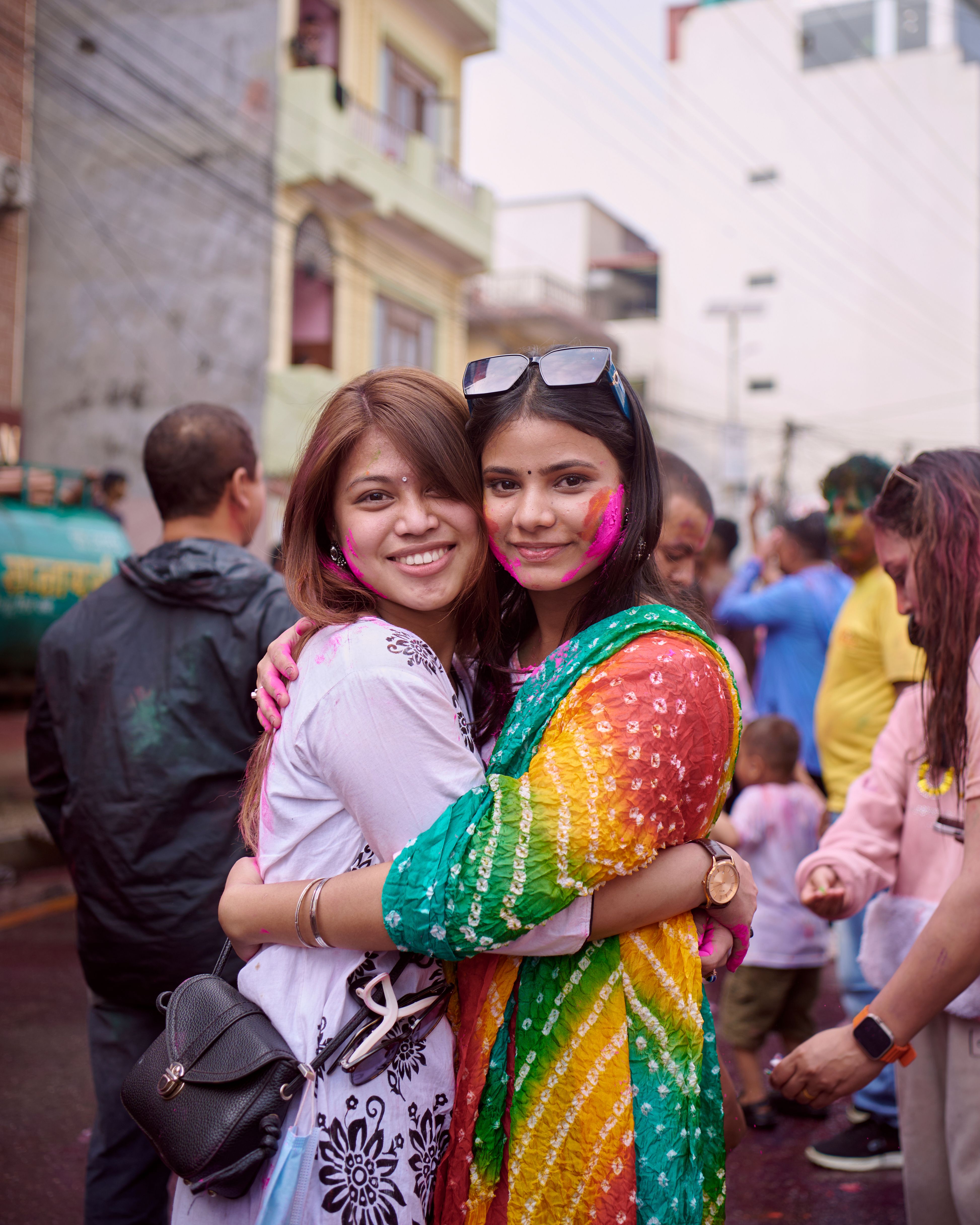 Women in Traditional Clothing Hugging on Street · Free Stock Photo