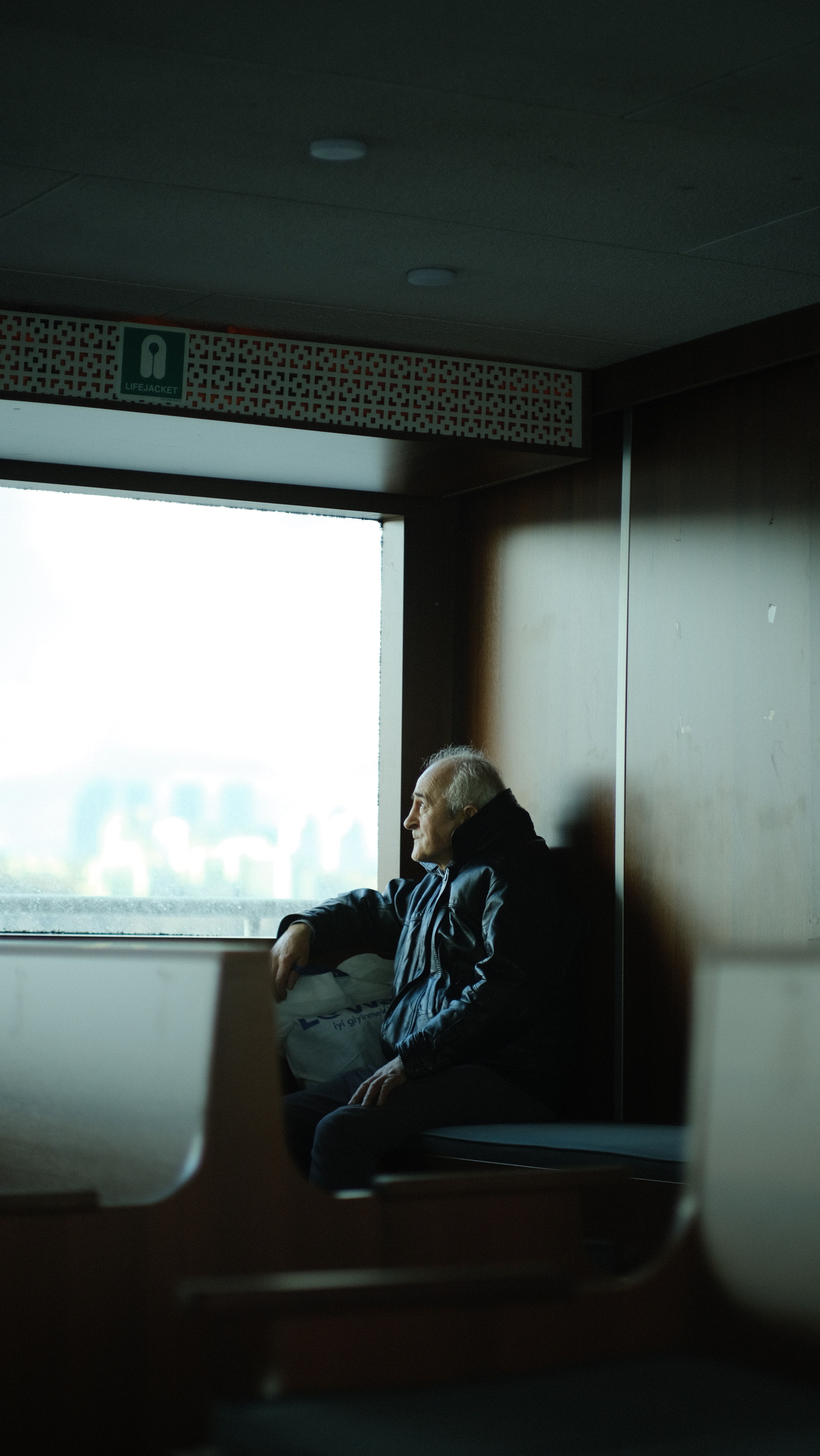 Man Sitting near Window on Ferry · Free Stock Photo