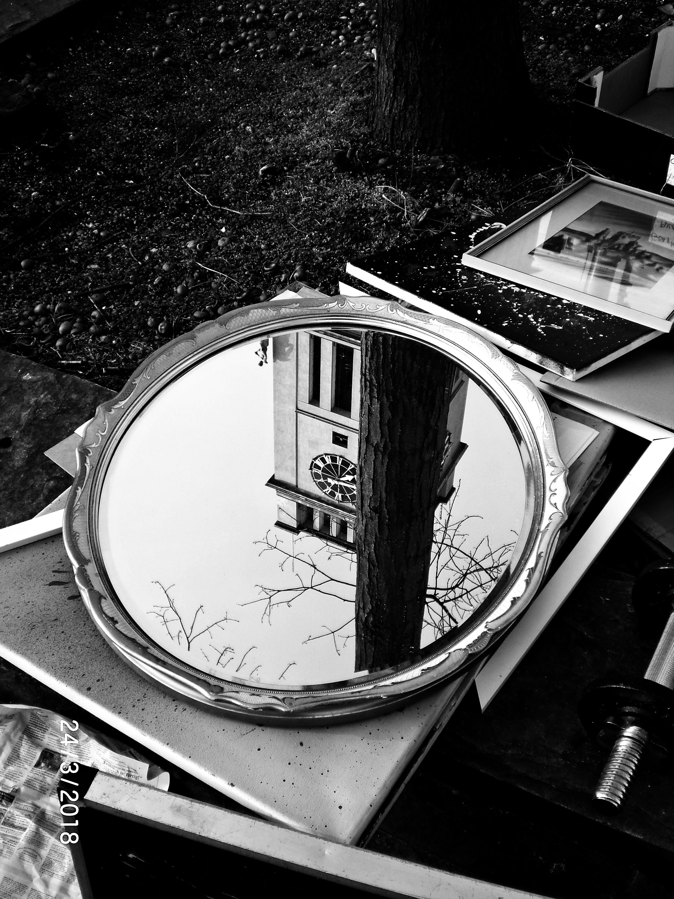 A mirror is sitting on top of a pile of items · Free Stock Photo