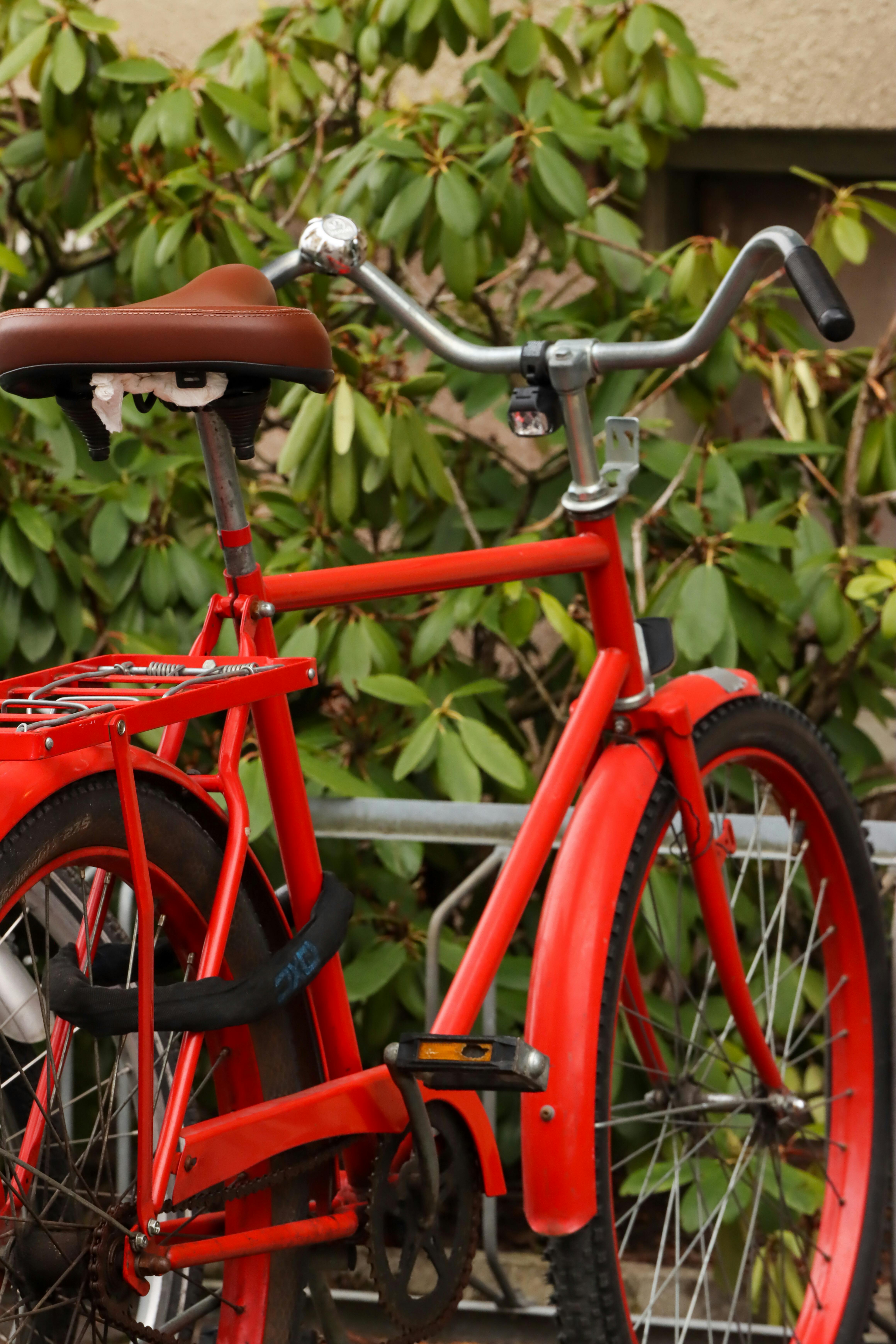 Red Bicycle Parked Near Brick Wall in Druskininkai · Free Stock Photo