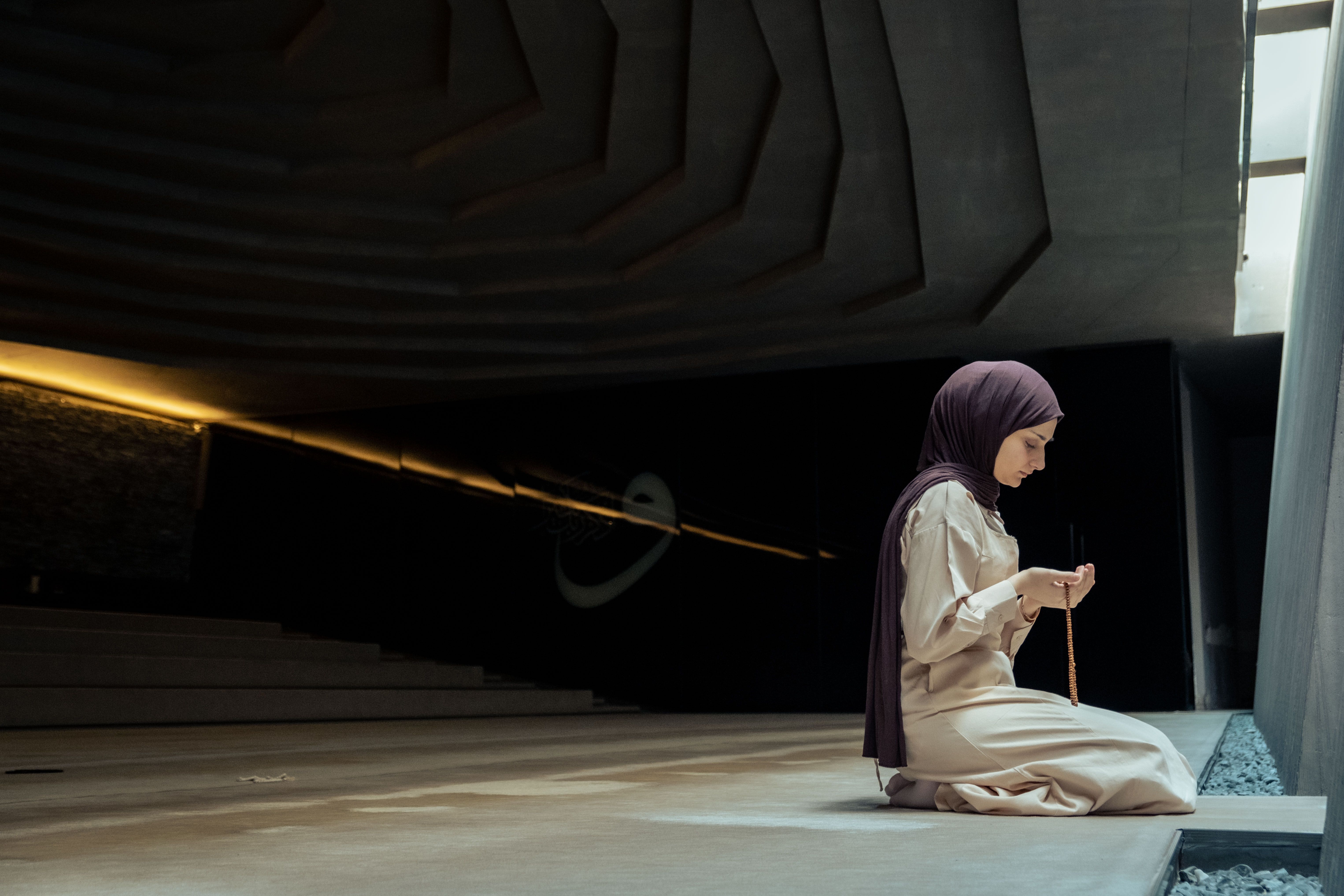 A woman in a hijab sitting on the floor · Free Stock Photo