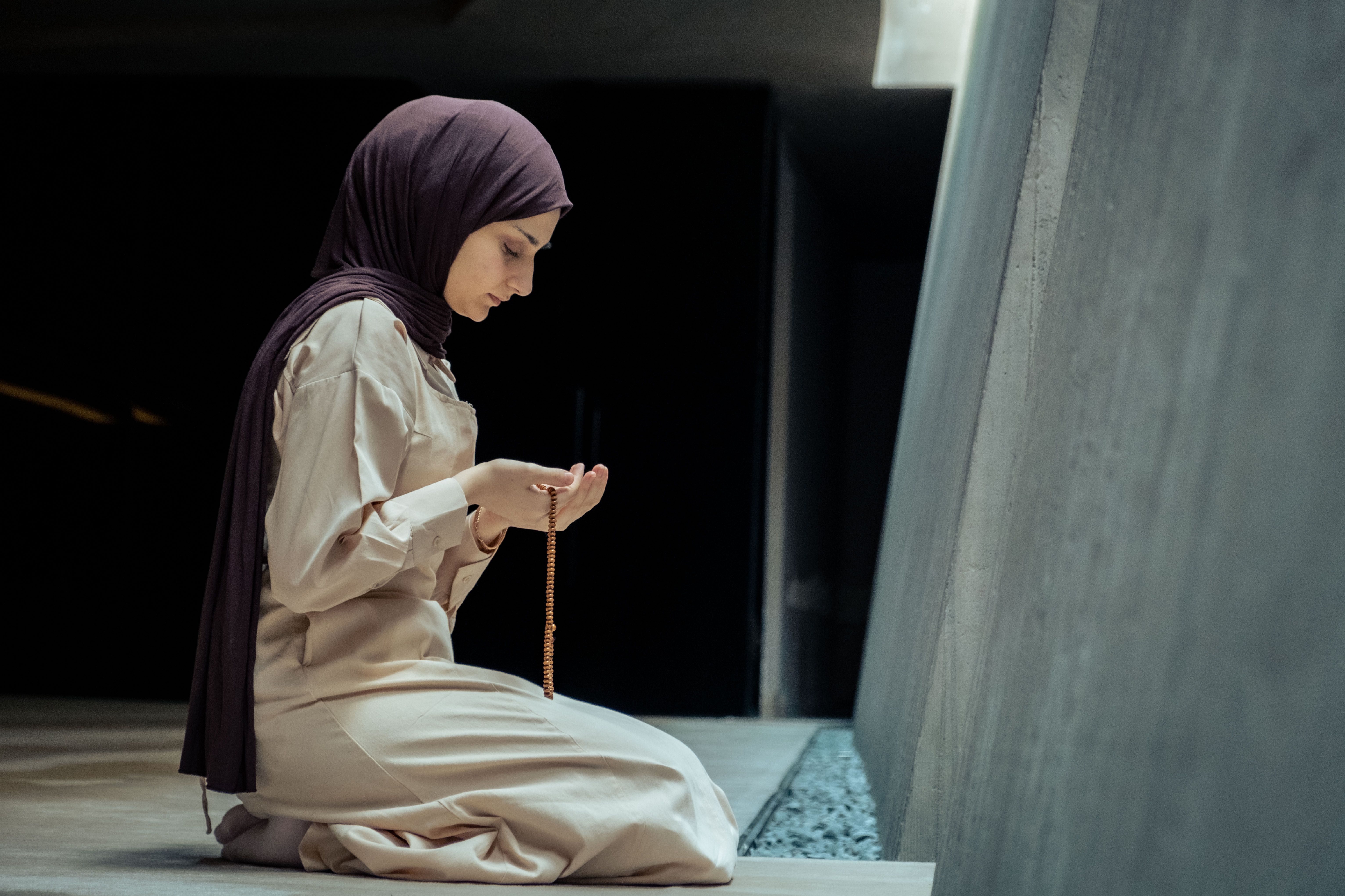 A woman in a hijab is praying · Free Stock Photo