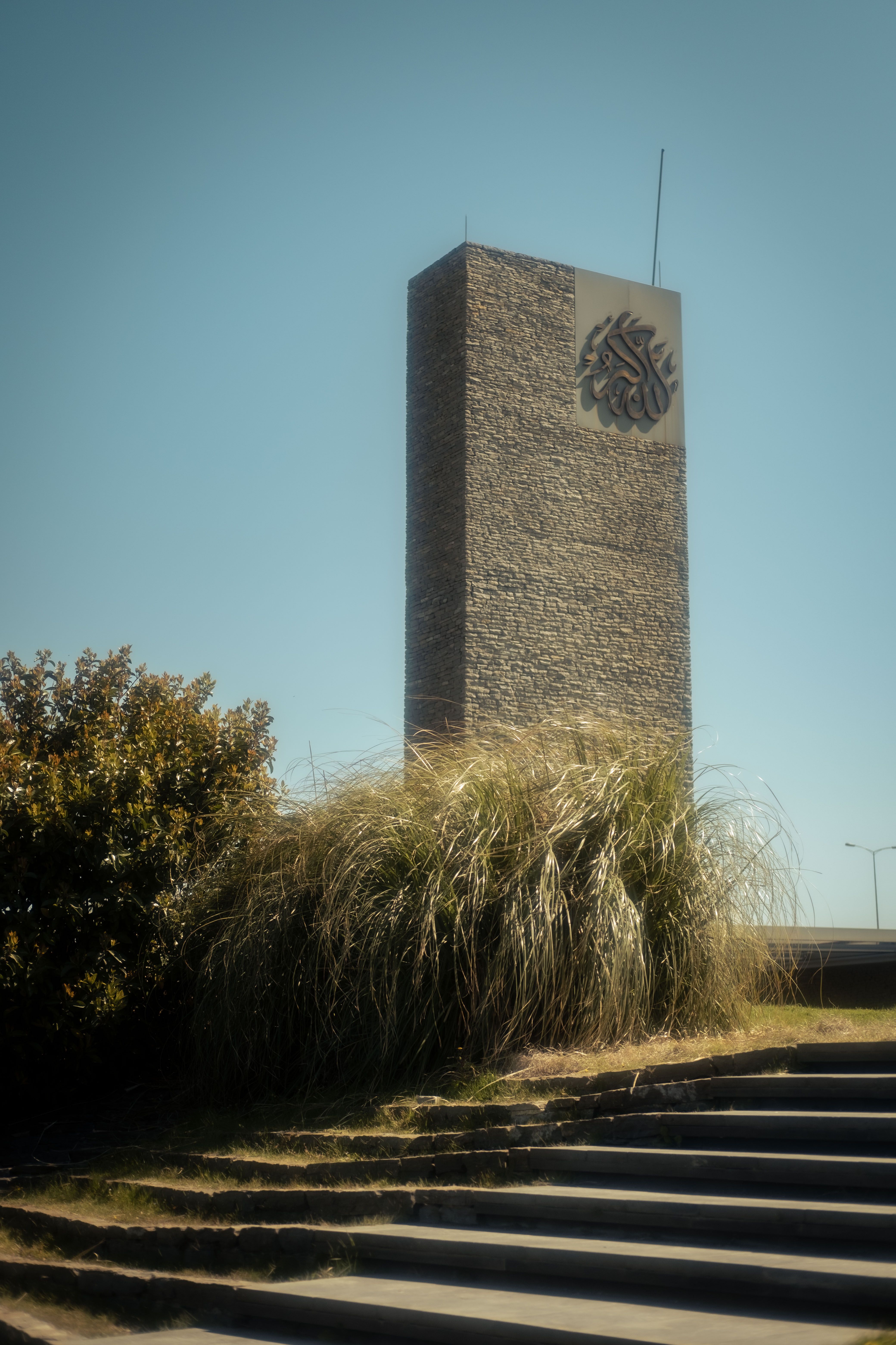 A clock tower with a clock on it sitting on top of a grassy hill · Free ...
