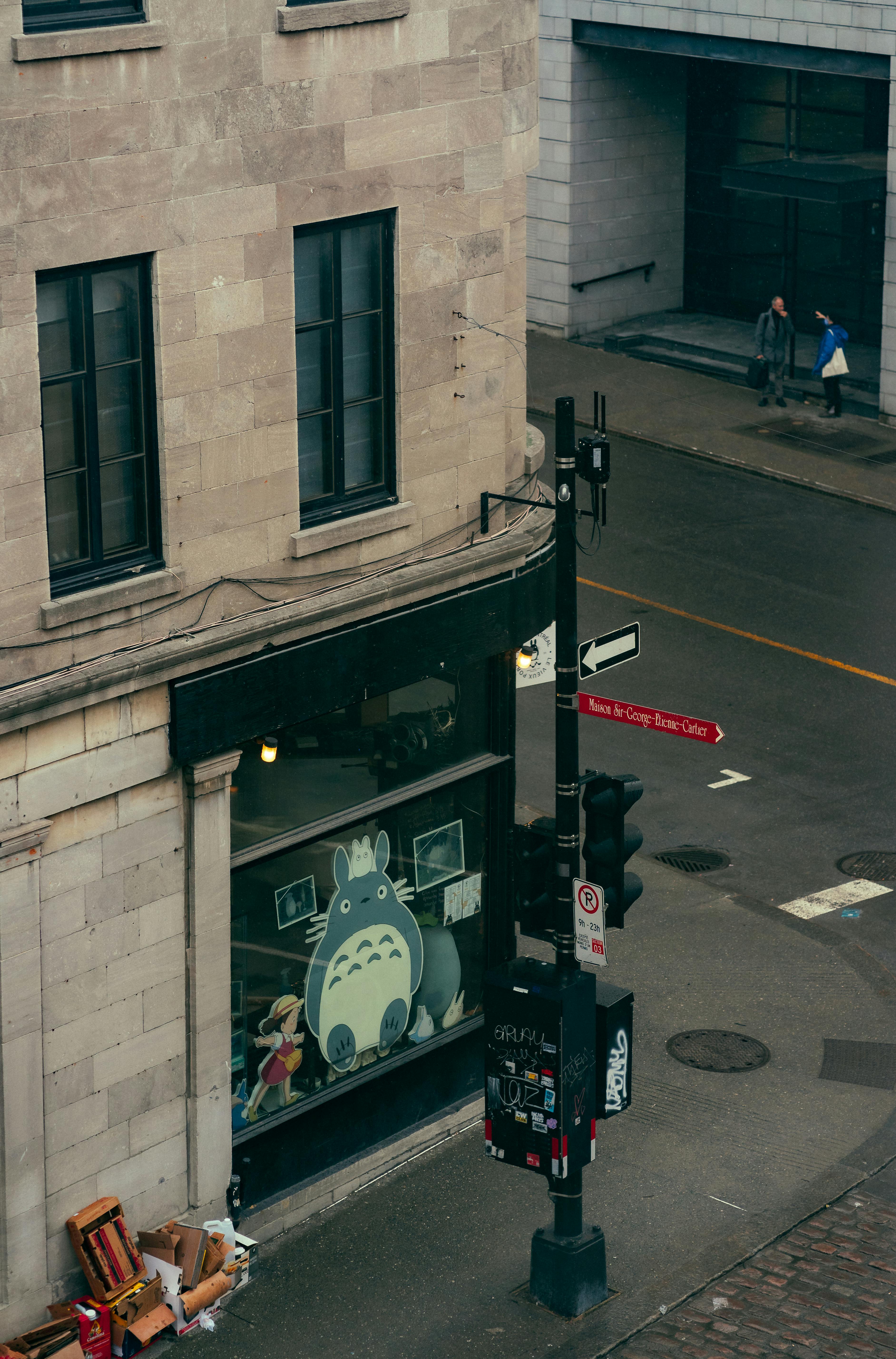 A street view of a building with a street sign · Free Stock Photo