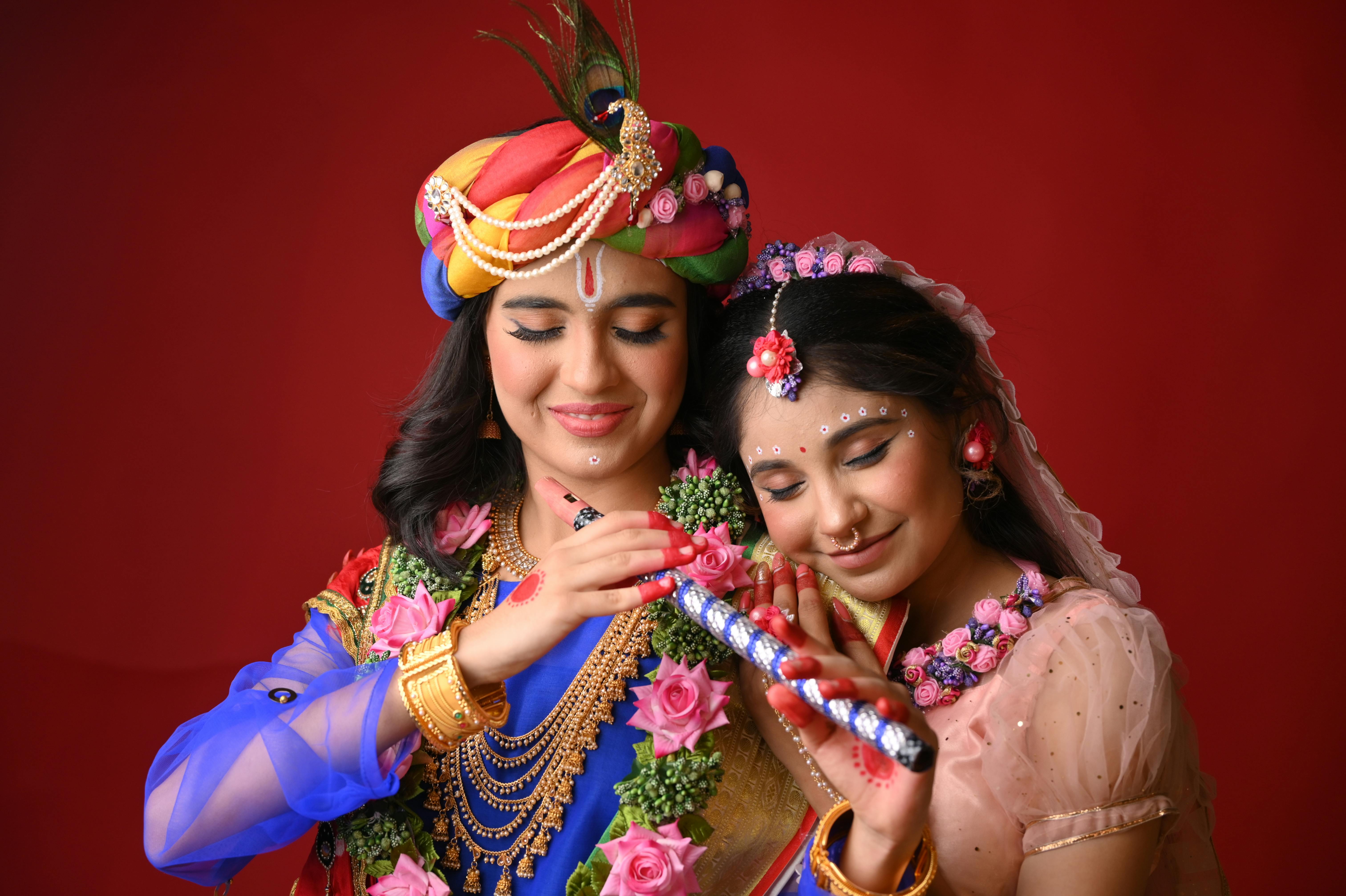 Smiling Young Women Dressed as Radha and Krishna · Free Stock Photo
