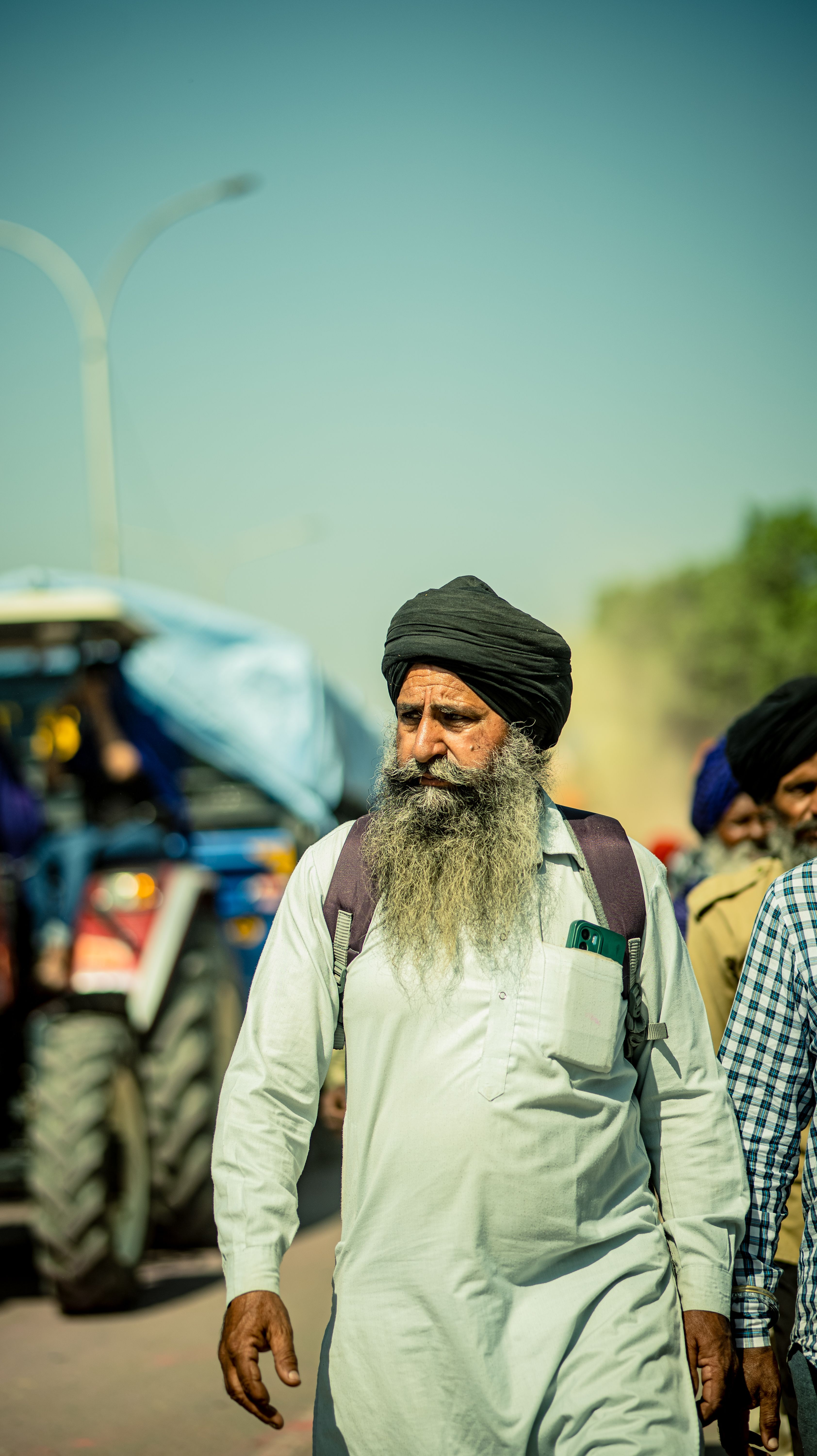A man with a long beard walking down a road · Free Stock Photo