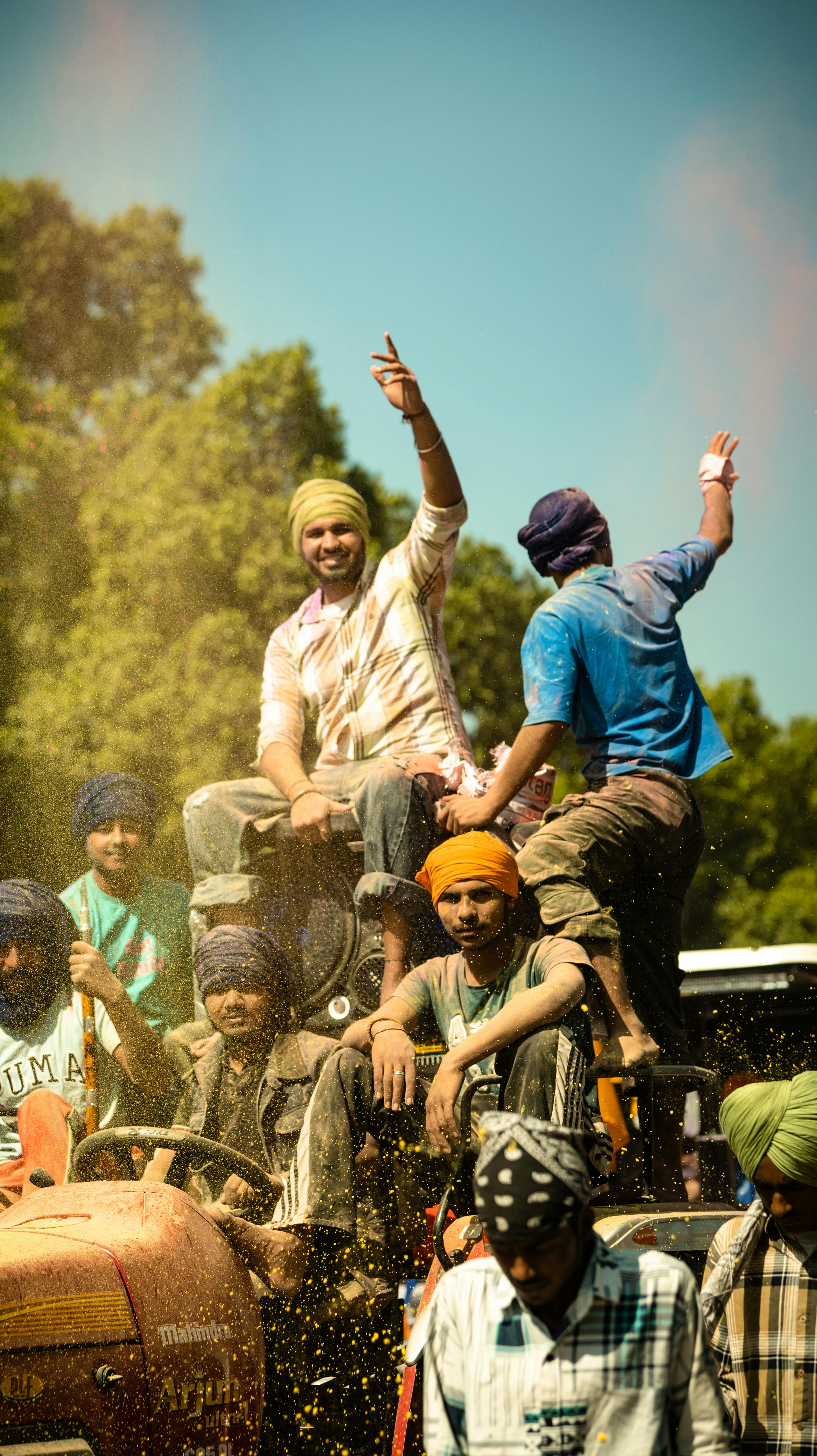 Group of Young Farmers by a Tractor · Free Stock Photo