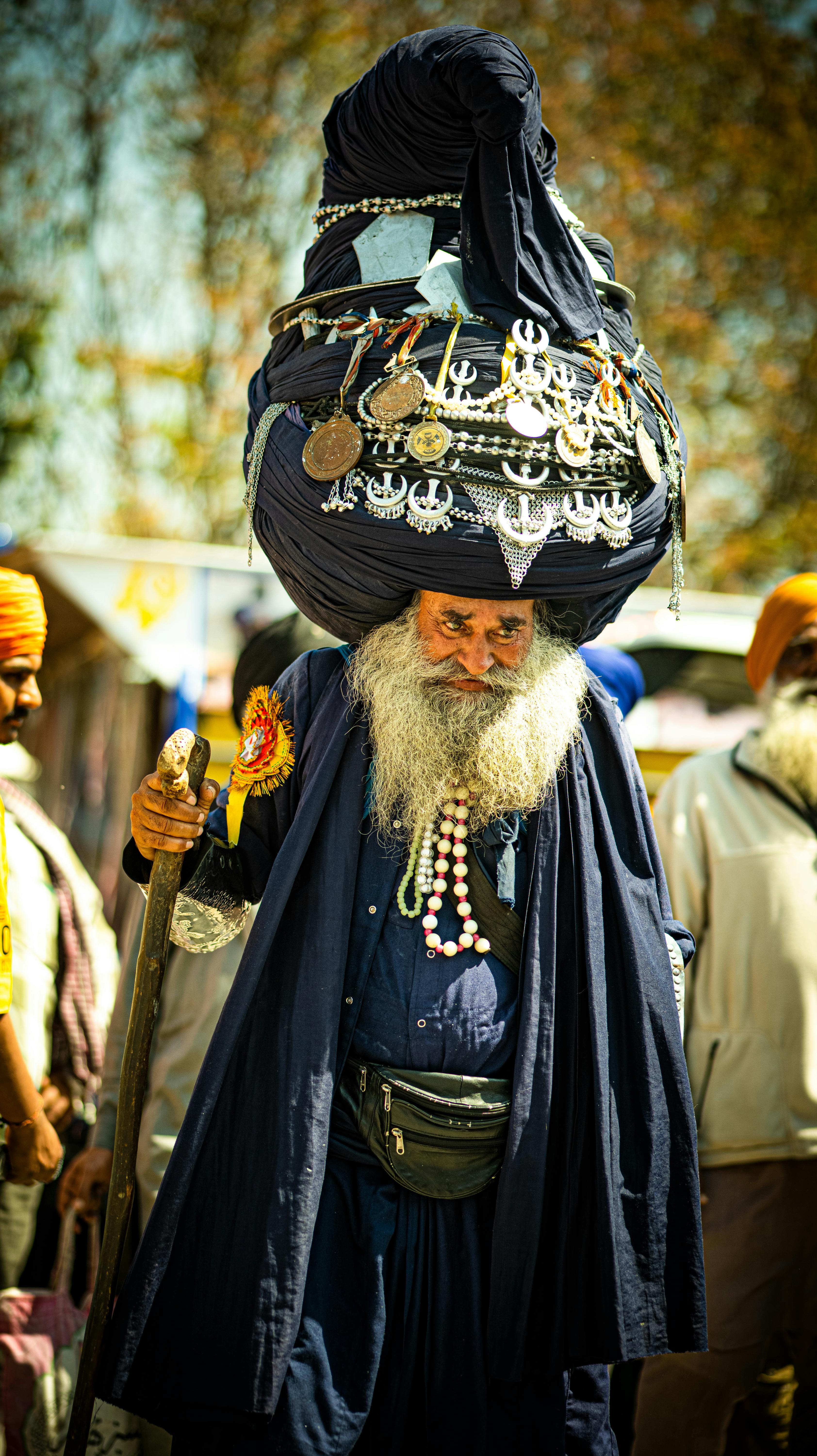 Man Standing with Rod in Traditional Clothing · Free Stock Photo