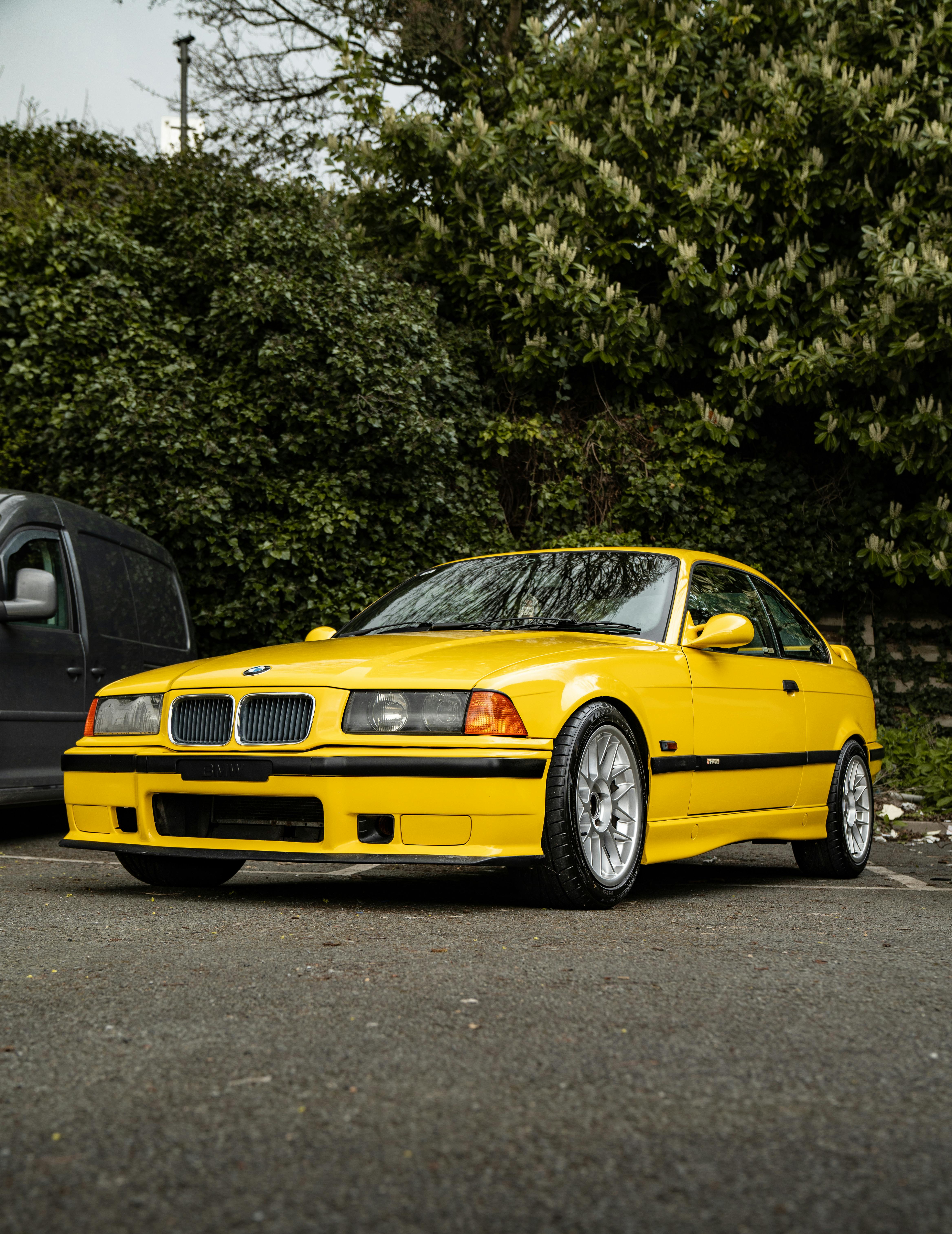 A Yellow BMW E36 in the Parking Lot · Free Stock Photo