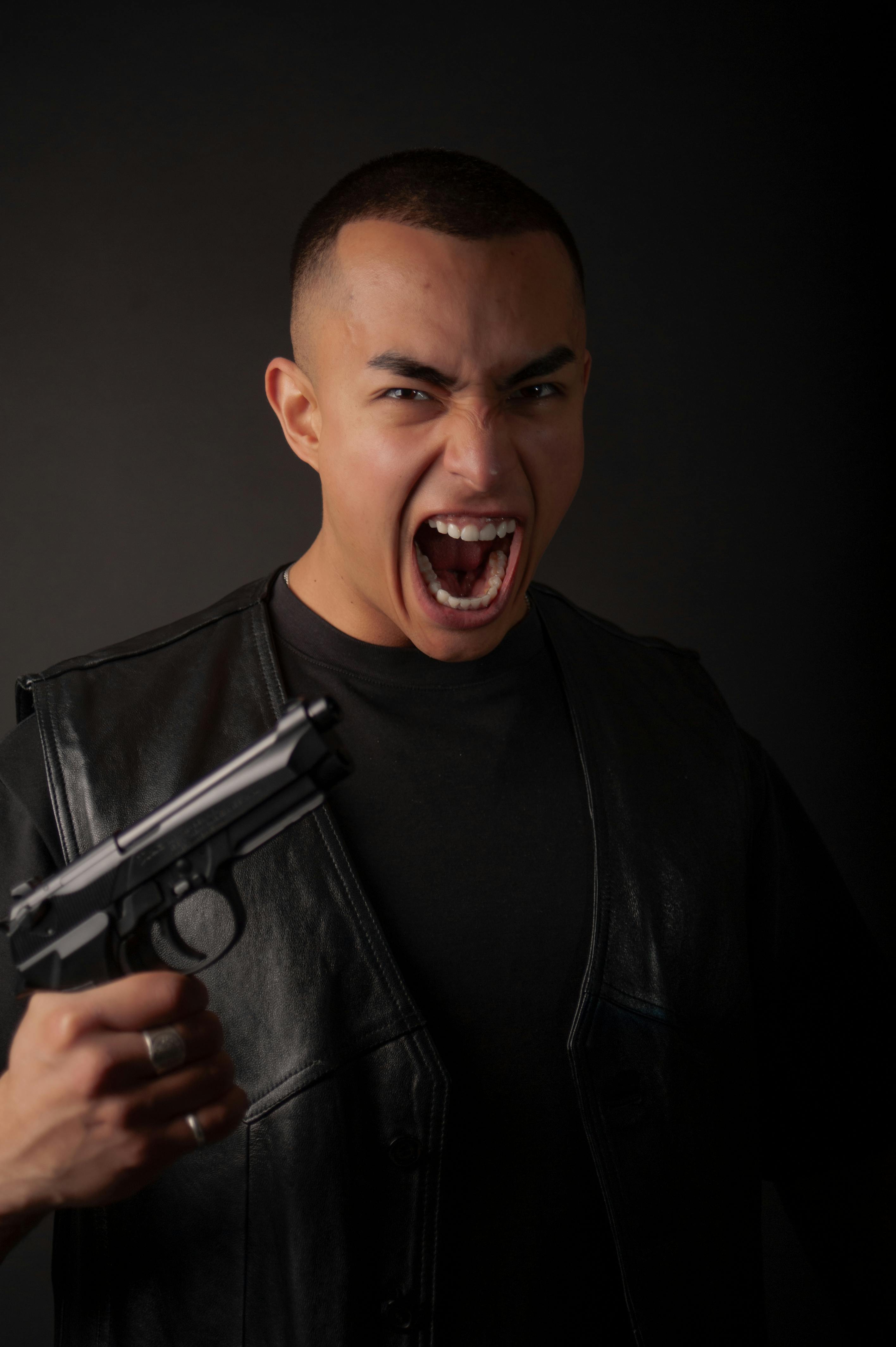 Mad Screaming Man Holding Gun · Free Stock Photo