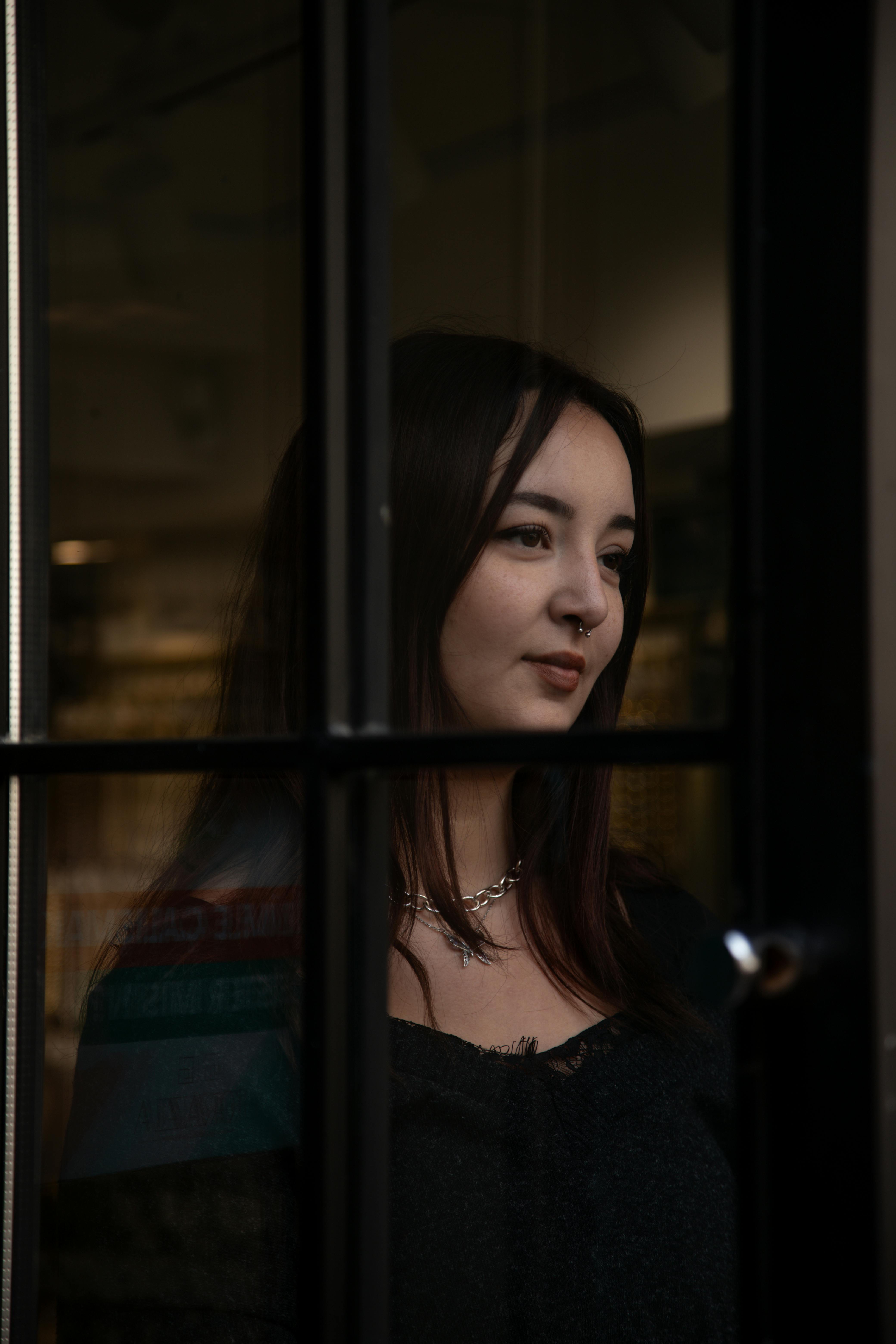Woman Standing in Window · Free Stock Photo