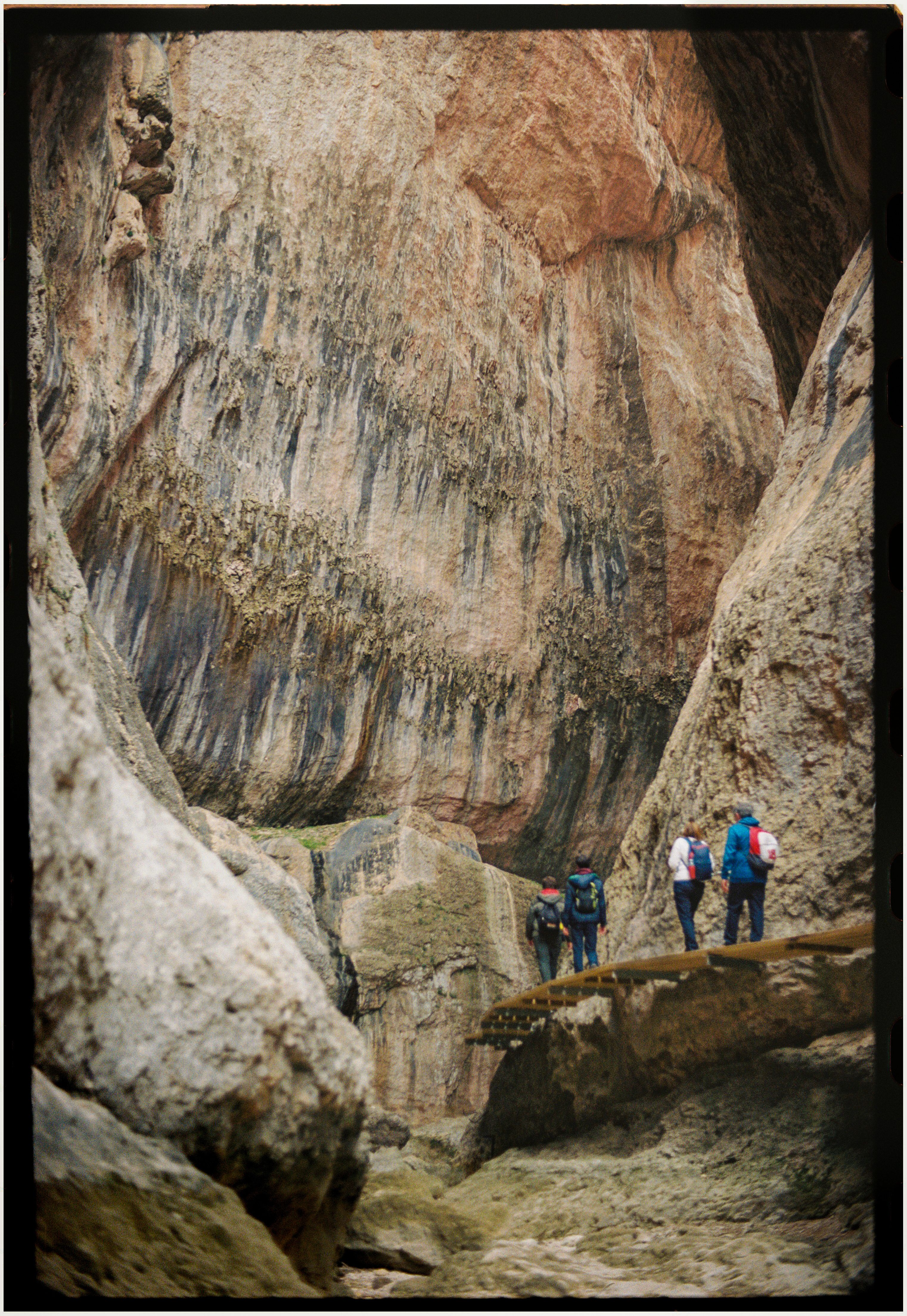 People Hiking in Barren Cave · Free Stock Photo