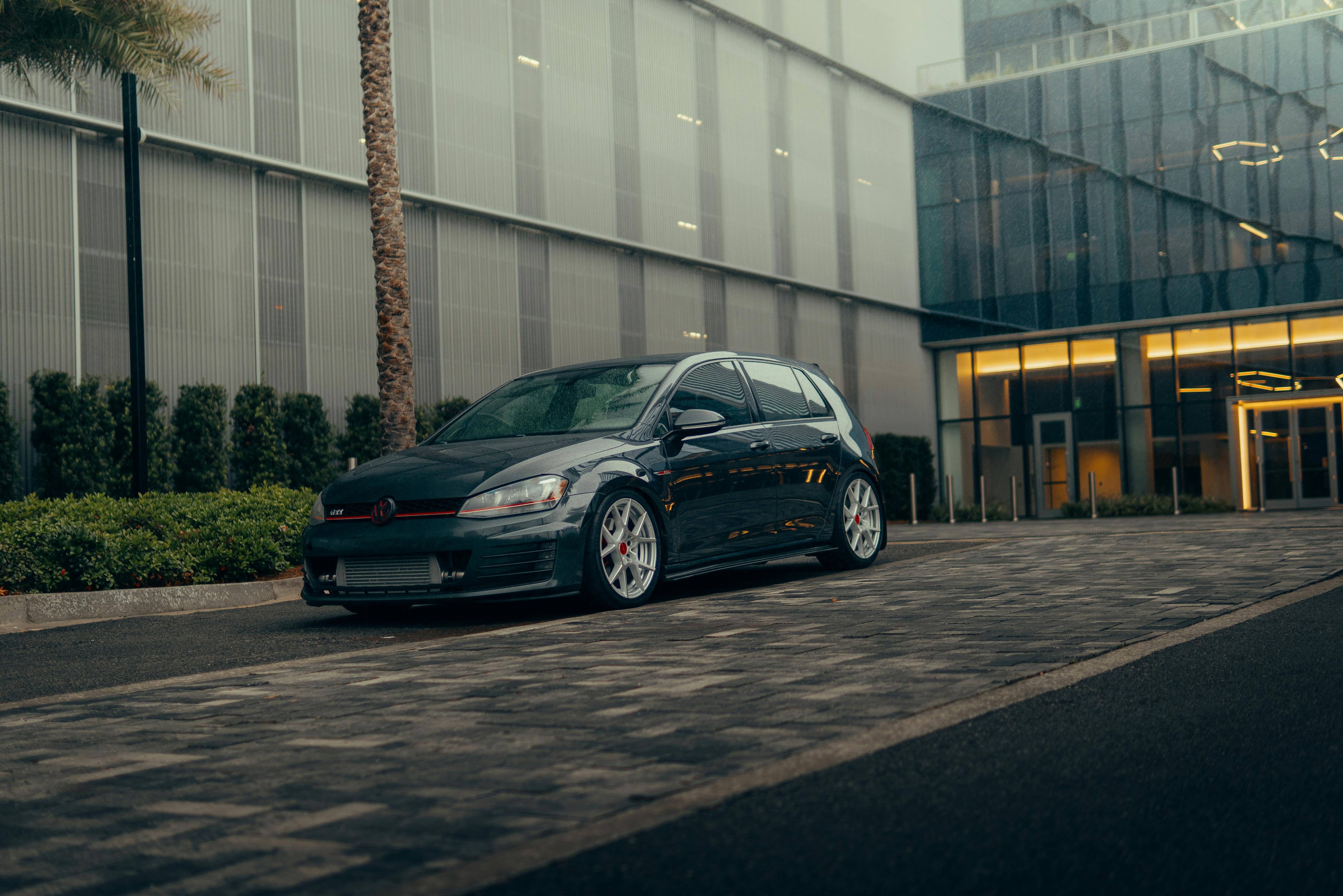 Volkswagen Golf GTI near Building · Free Stock Photo