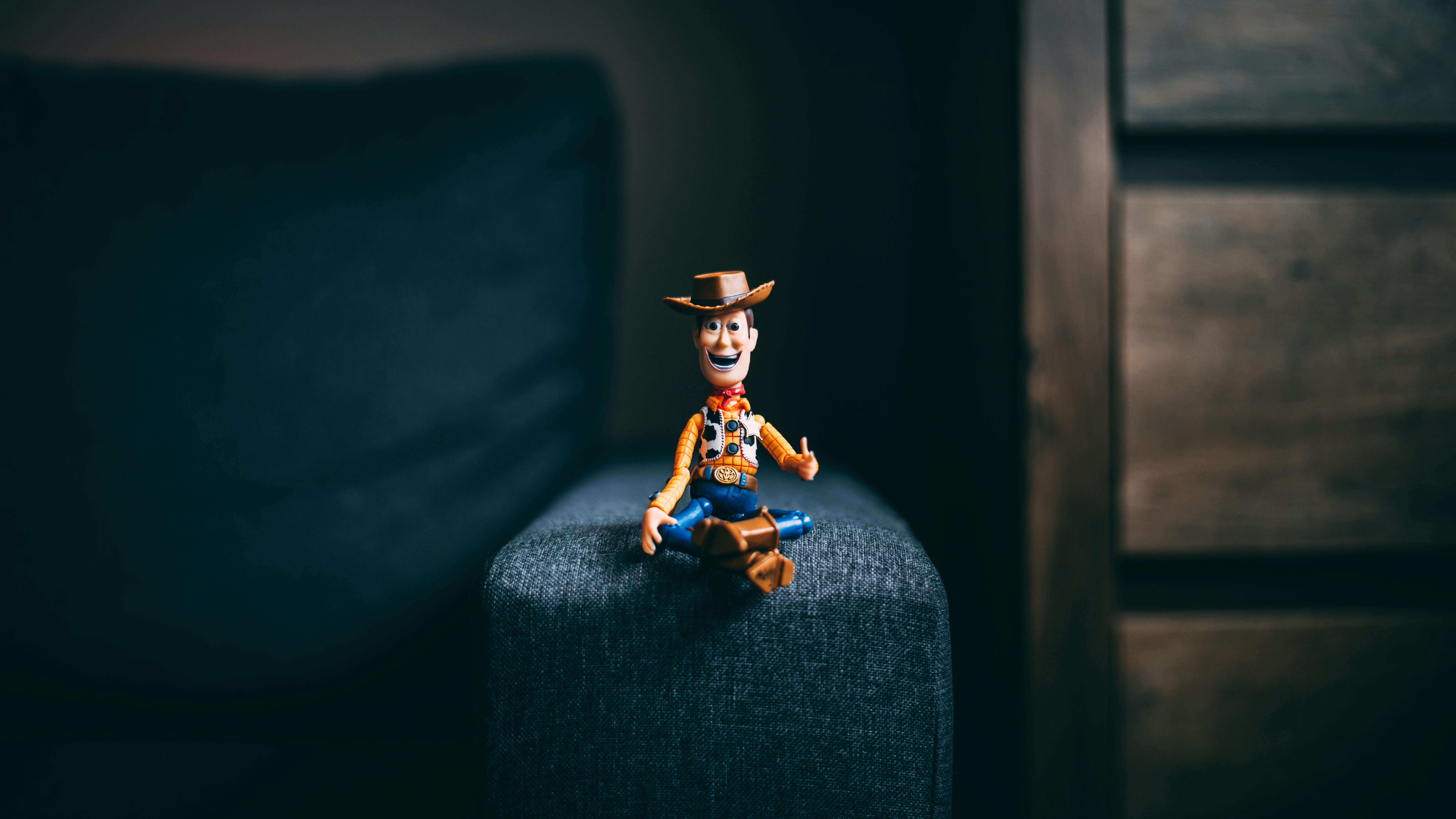 Figurine of Woody from Toy Story Sitting on the Armrests of the Sofa ...