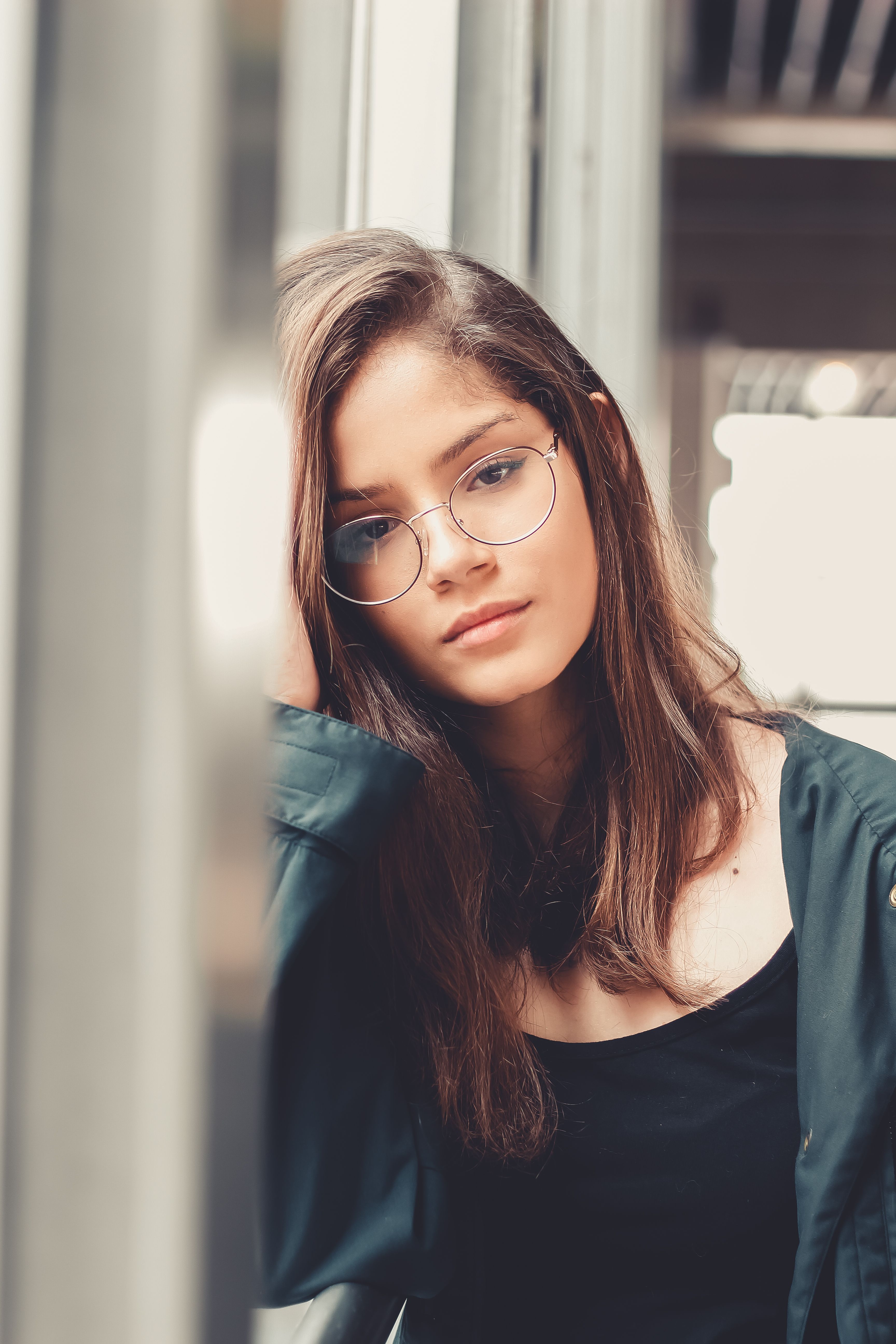 Photo of Woman Leaning Her Head on Glass Window · Free Stock Photo