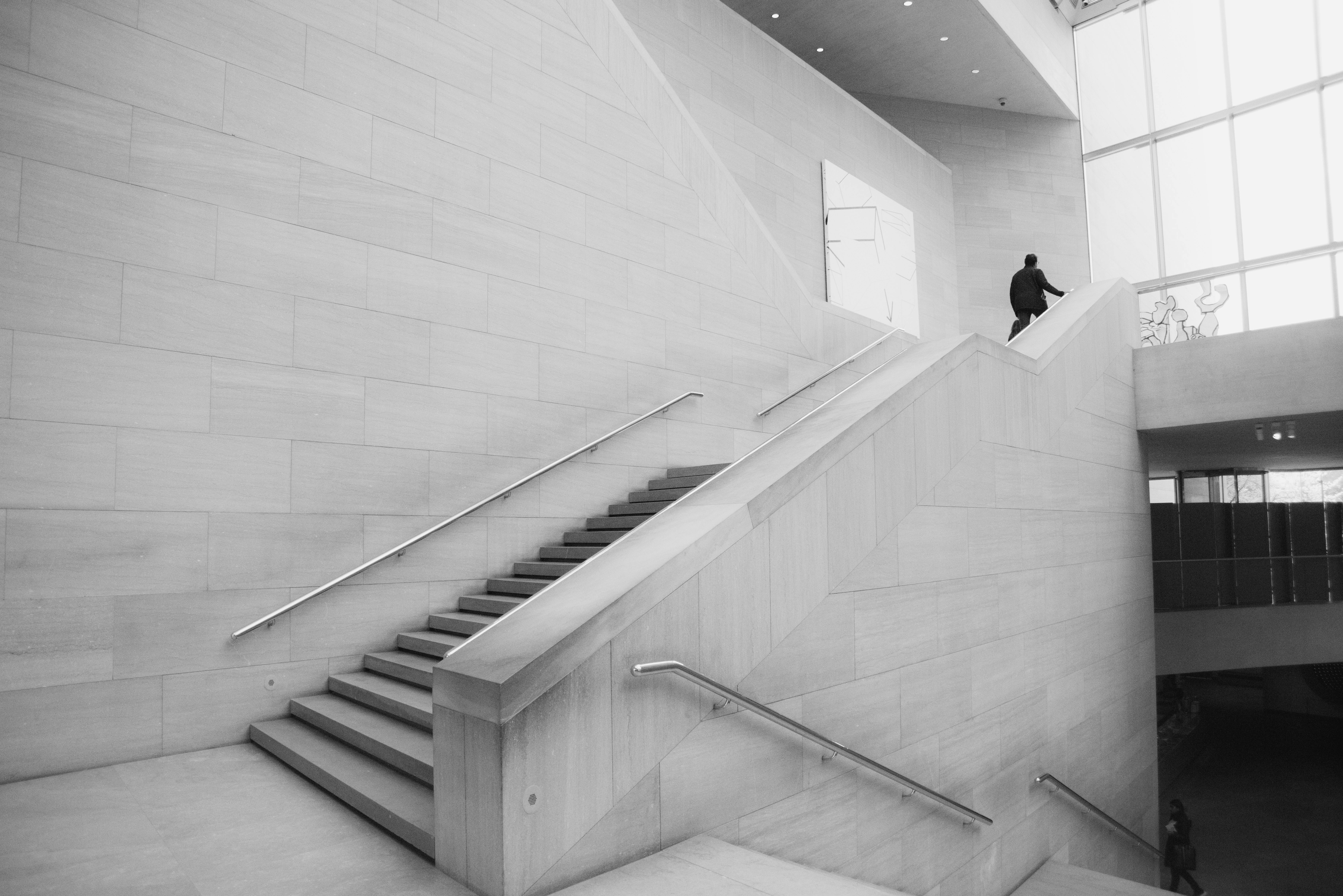 Person Walking Up Stairs Grayscale Photo · Free Stock Photo