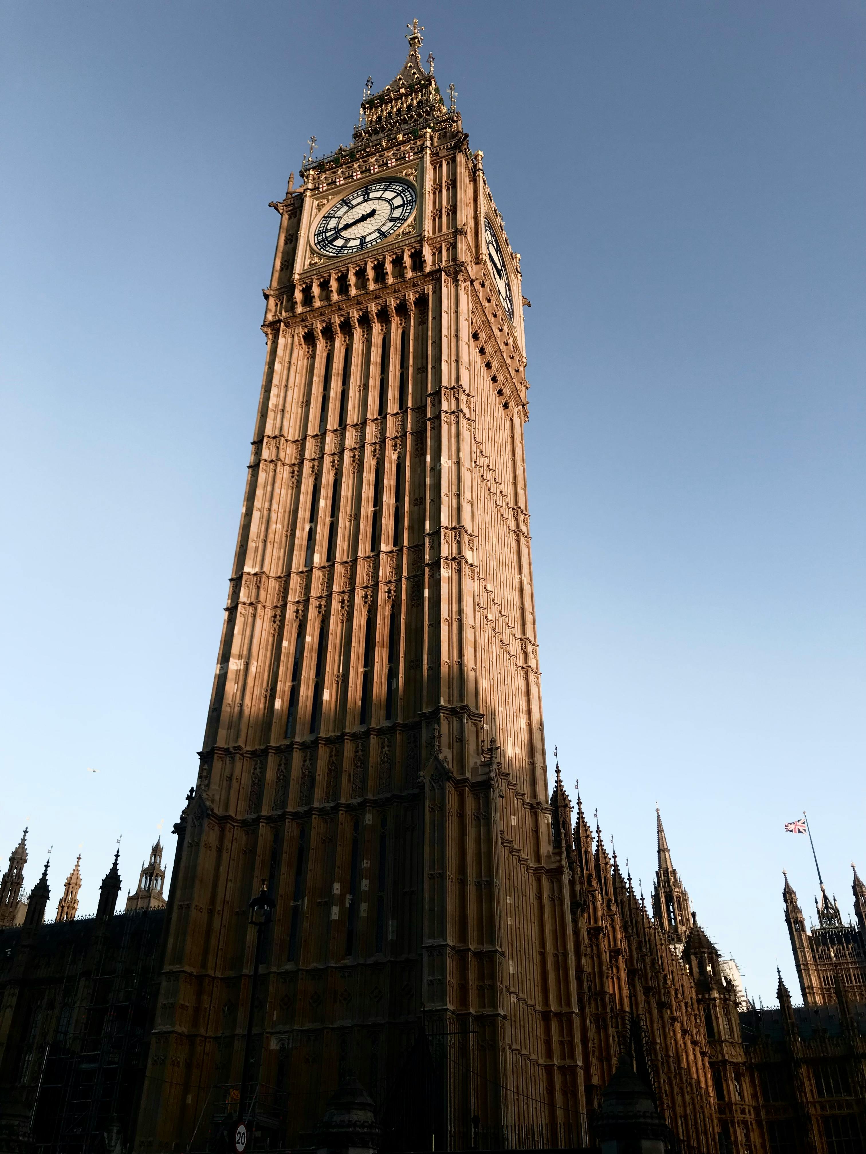 Low Angle View of Clock Tower Against Blue Sky · Free Stock Photo