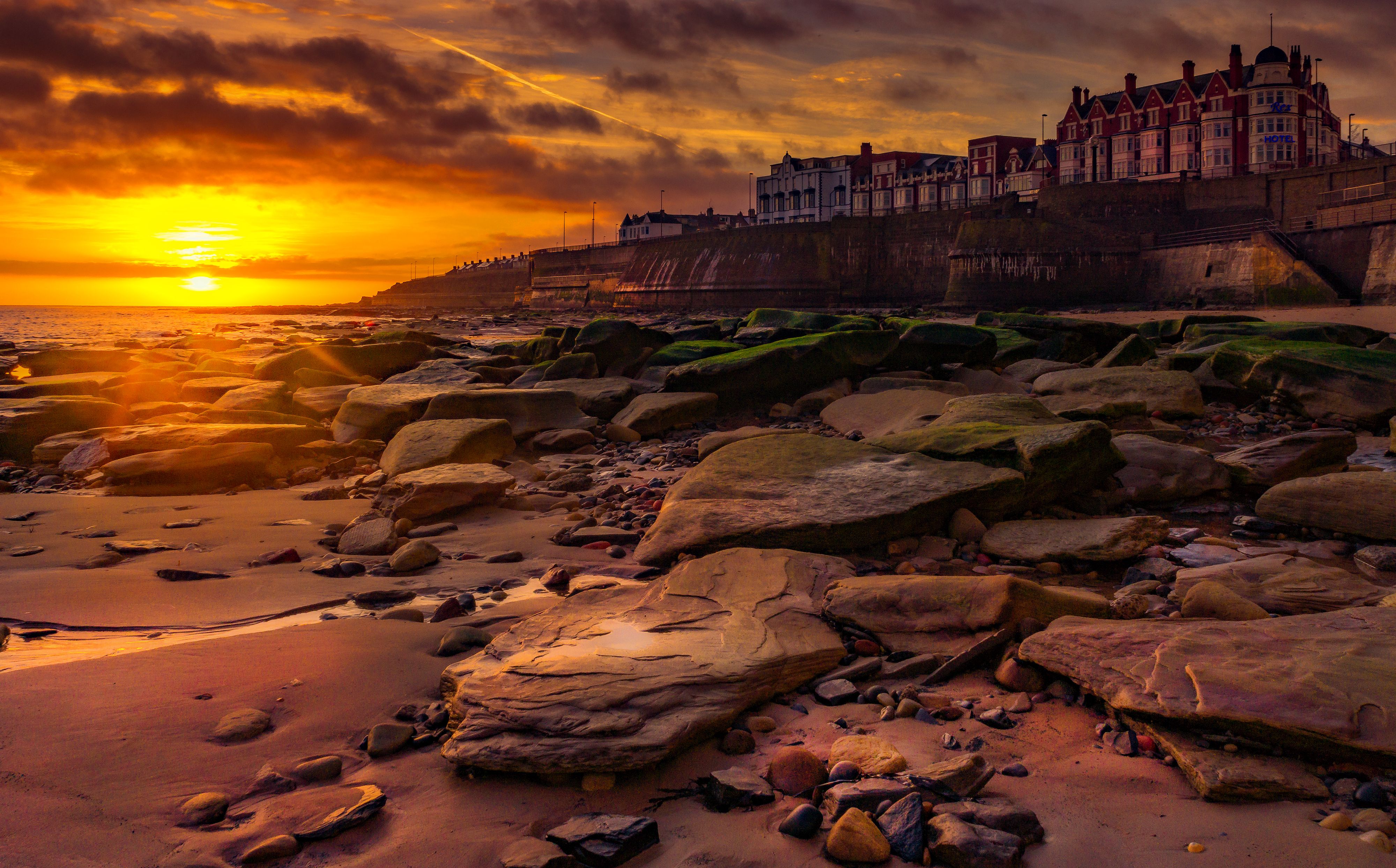 Buildings near Seashore at Sunset · Free Stock Photo